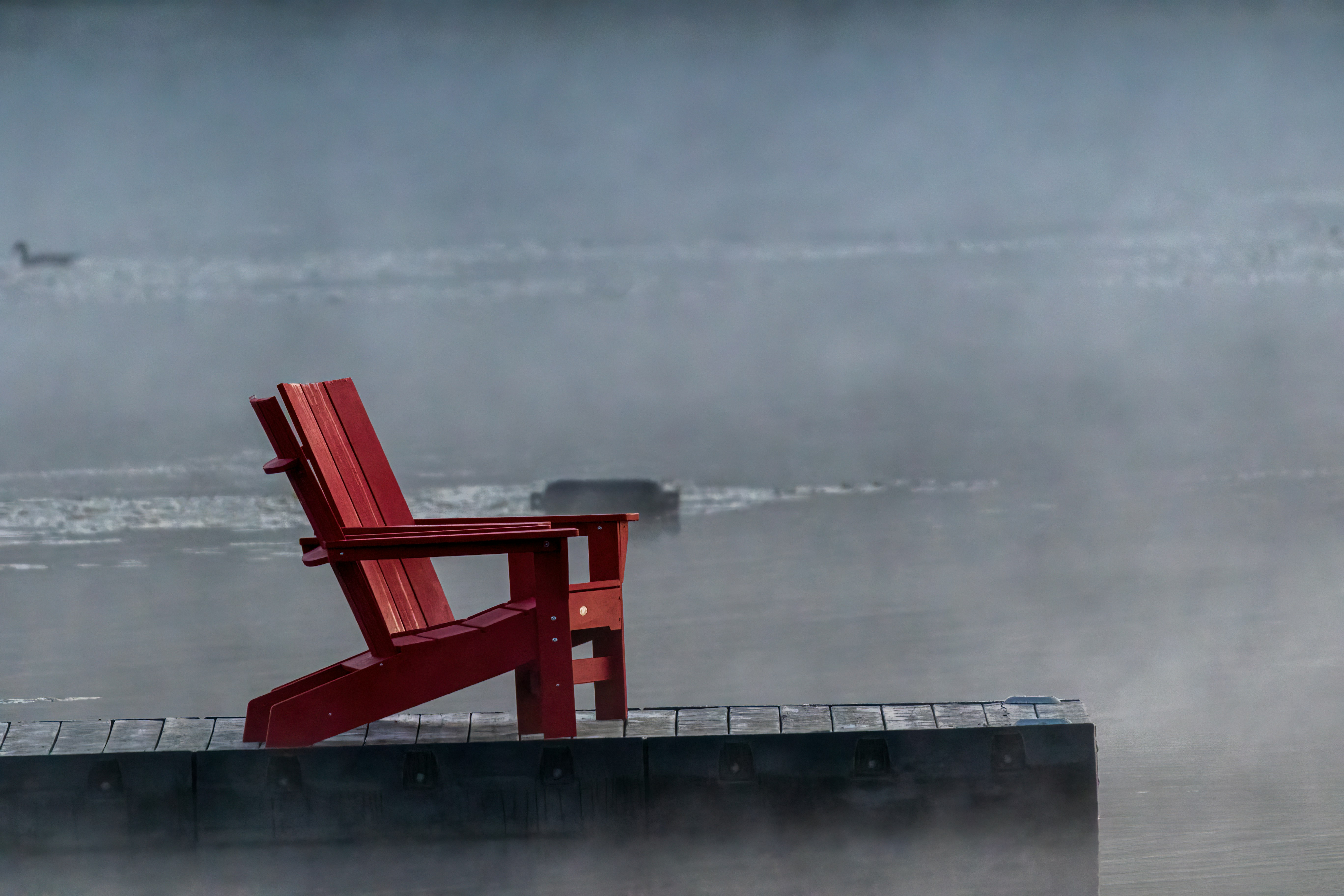 Red Adirondack on a Mist-Wrapped Pier