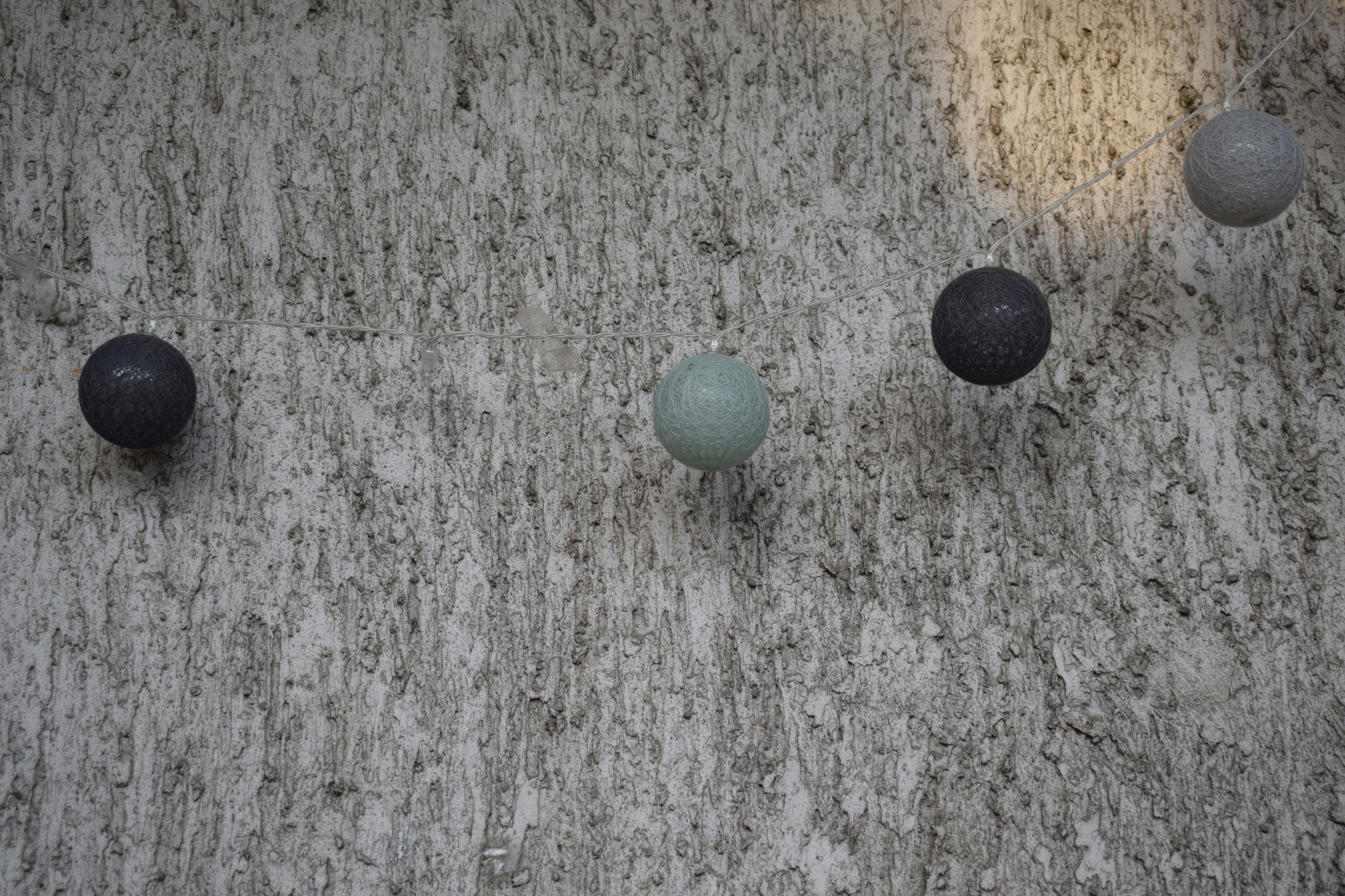 a group of balls sitting on top of a cement floor