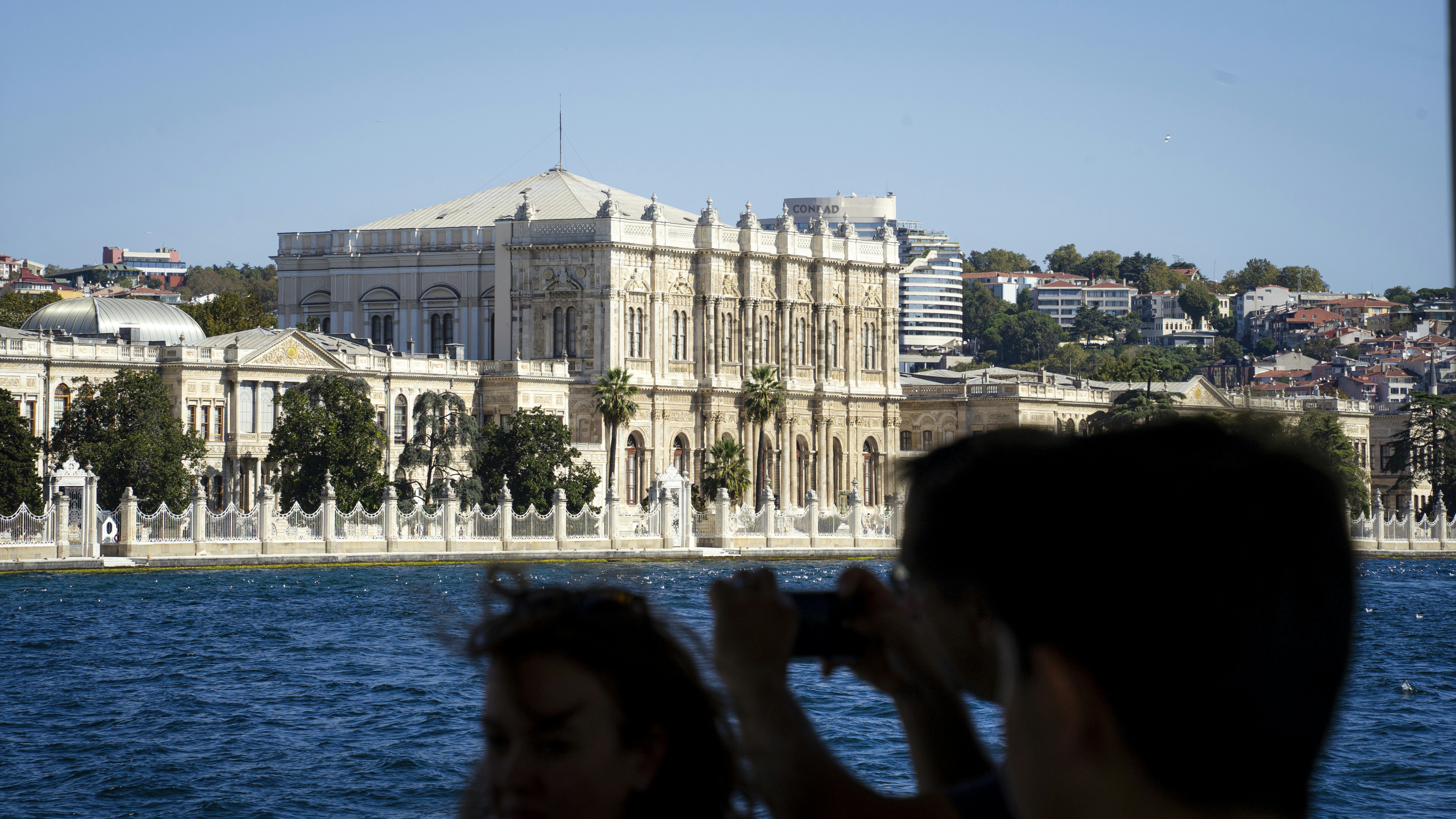 Harbor Facade in Focus: A Cameraman Frames a Grand Neoclassical Quay