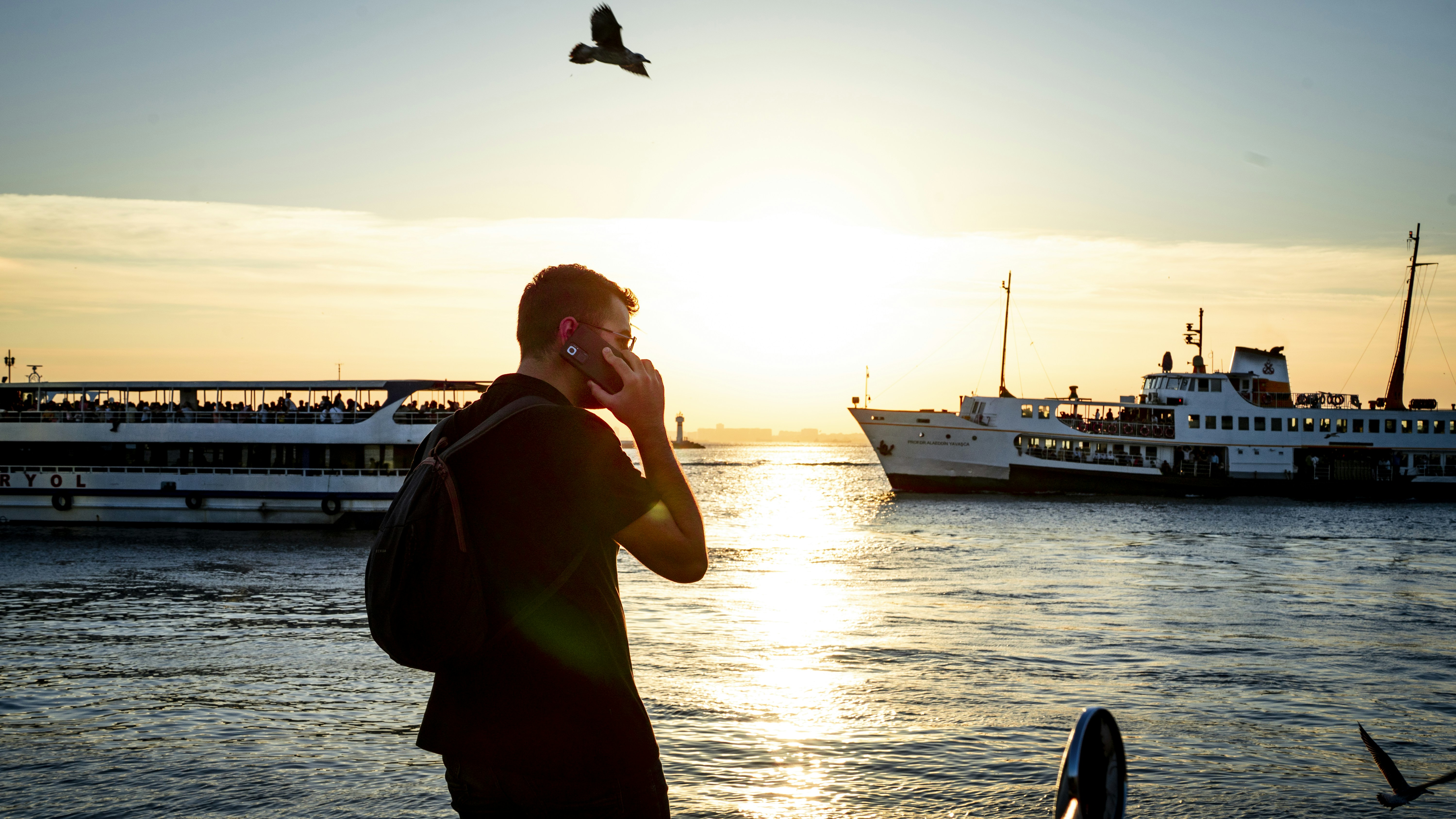 Backlit Moment: A Traveler on the Waterfront at Sunset