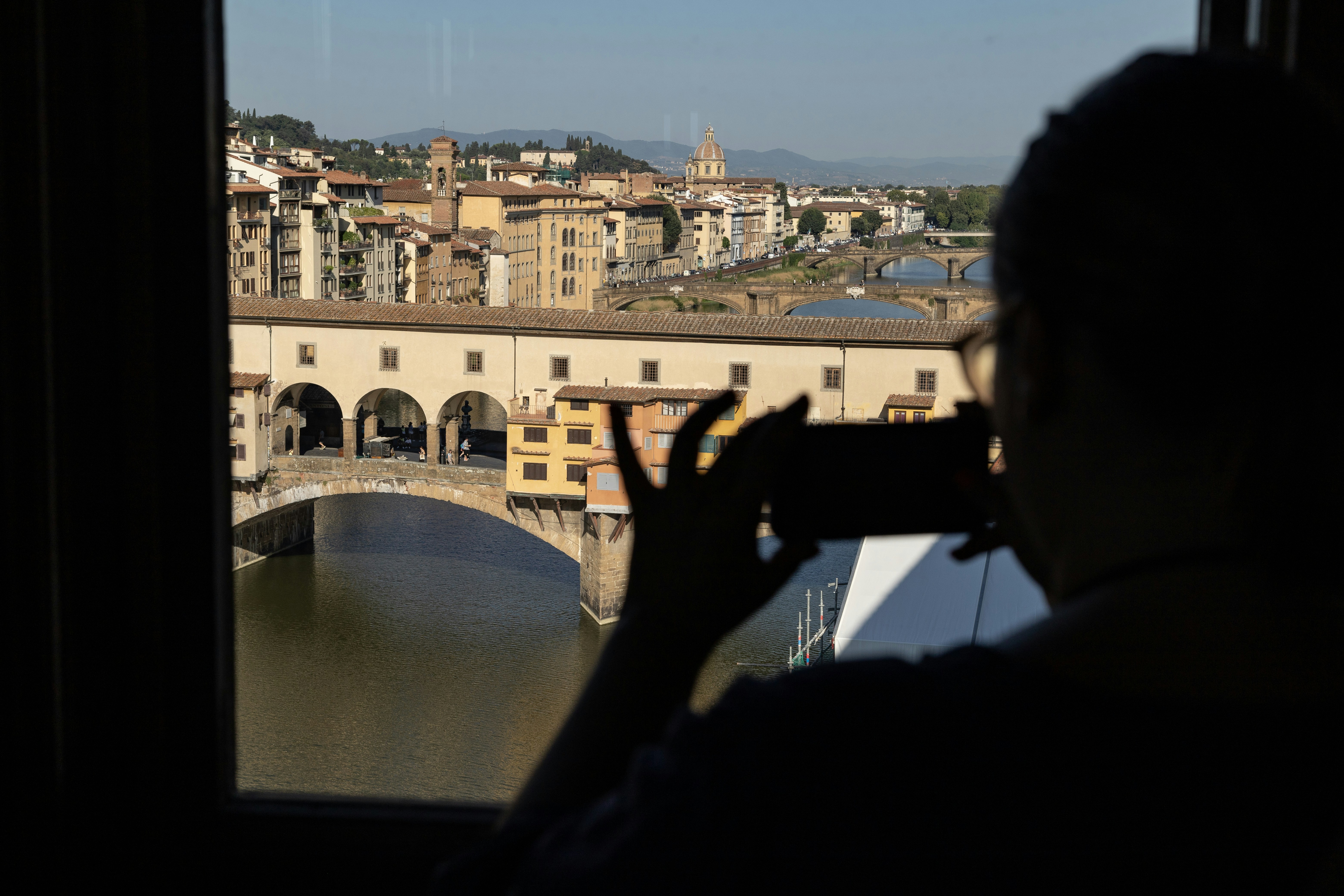 Framed Ponte Vecchio Over the Arno: A Silhouette's Window Portrait