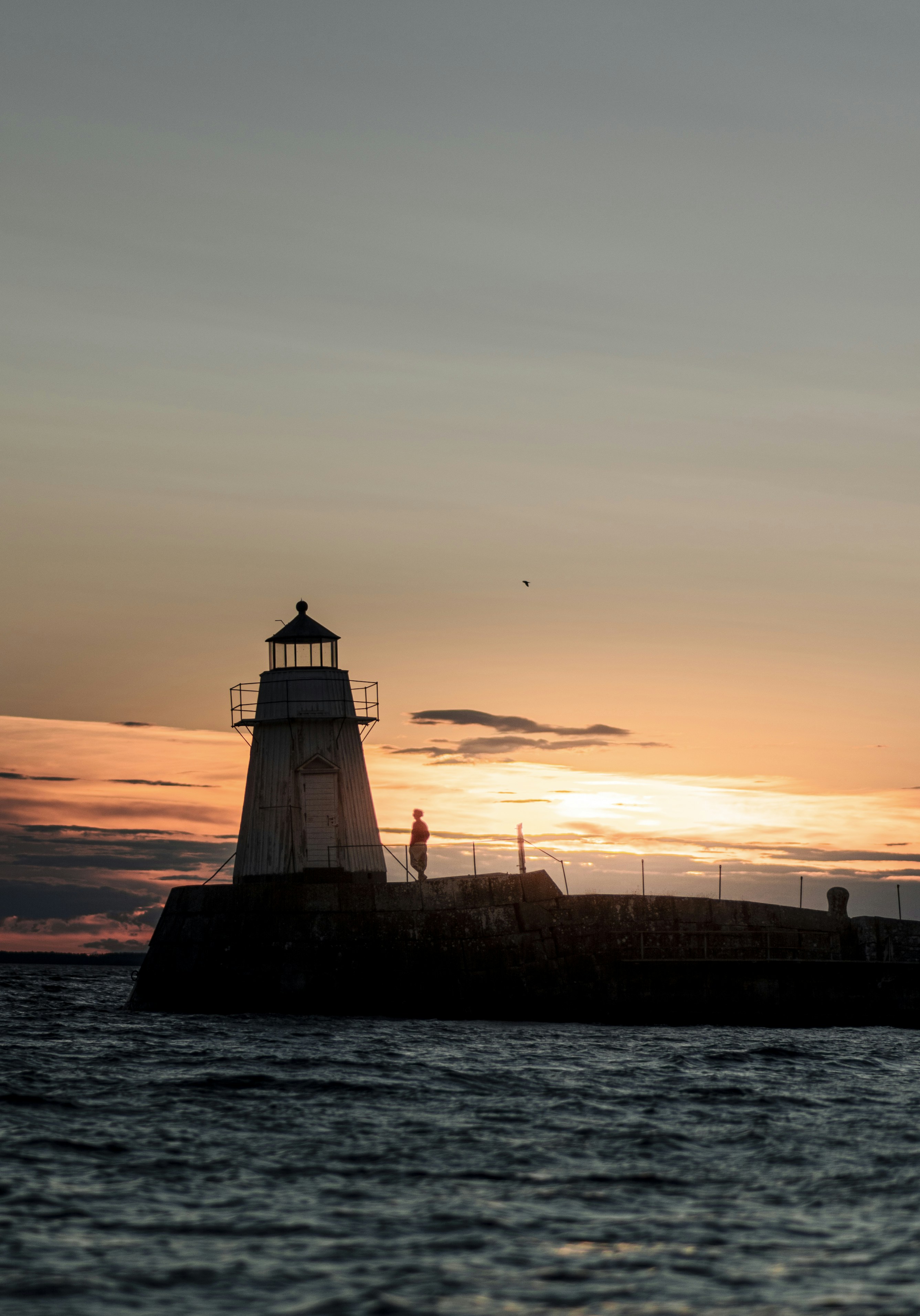 A light house sitting on top of a body of water photo – Free Lighthouse ...