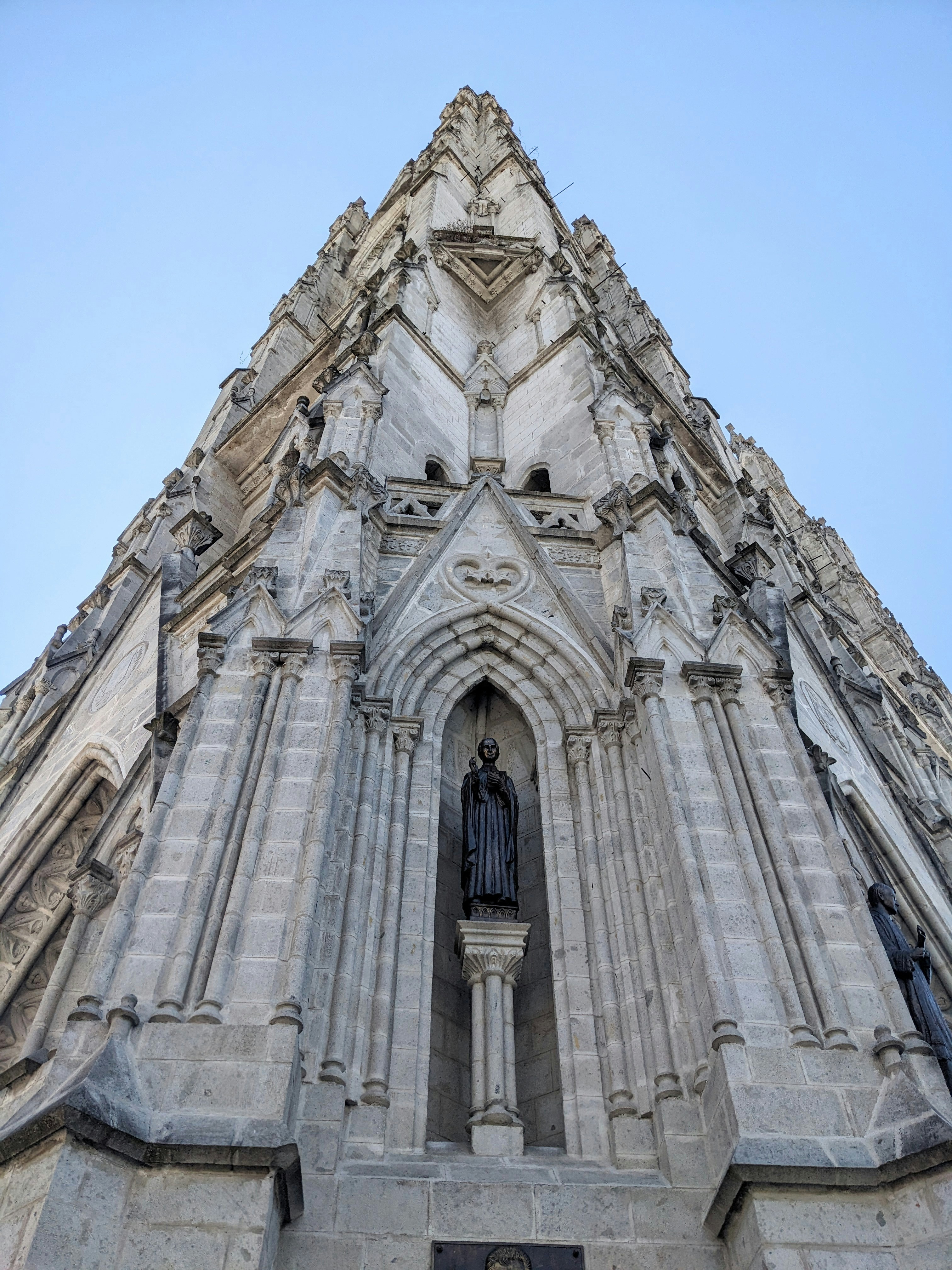 Stone Spire Ascends: A Gothic Cathedral's Central Statue Reaches Skyward