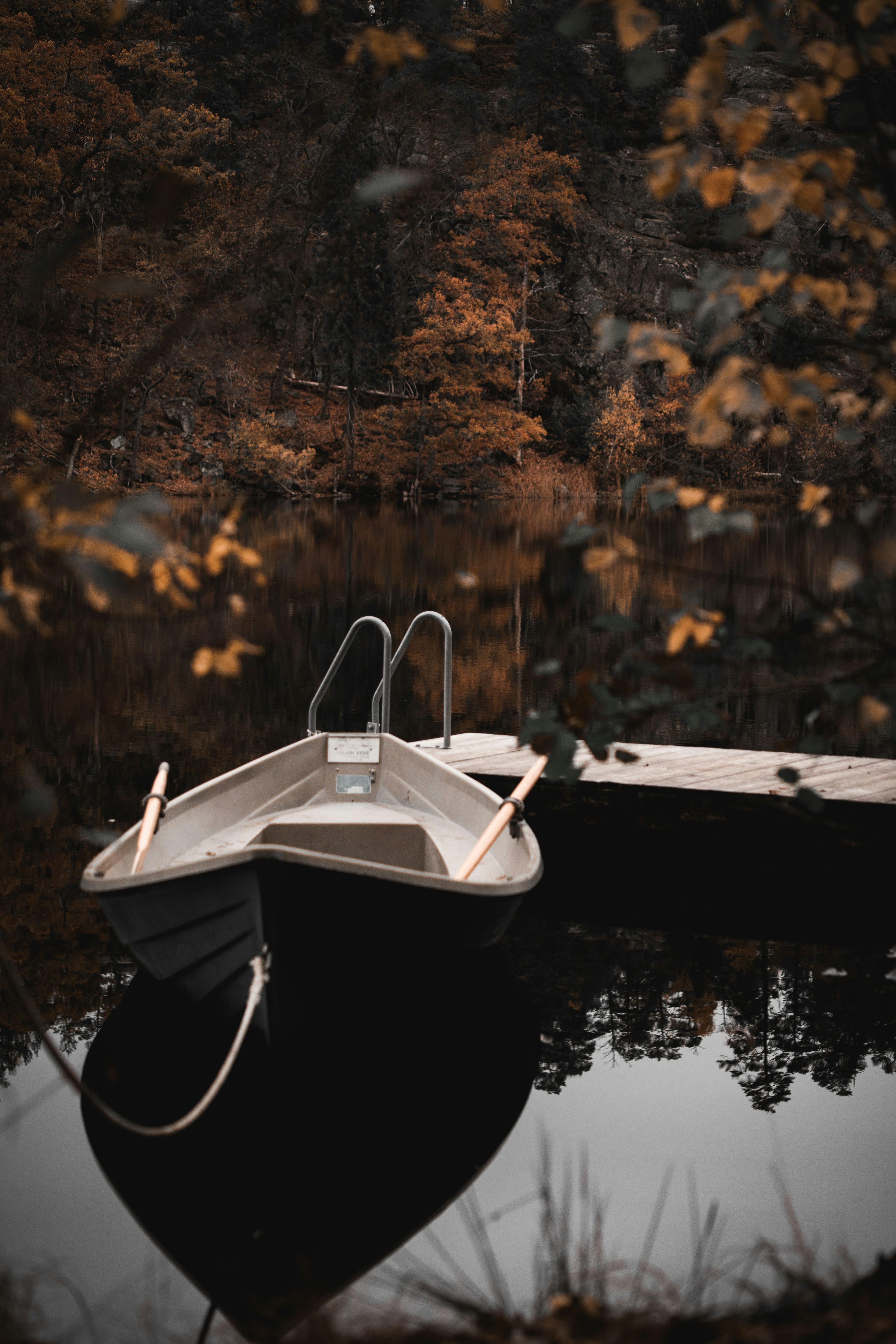 Dusk on a Still Lake: A Lone Rowboat in Autumn Hush