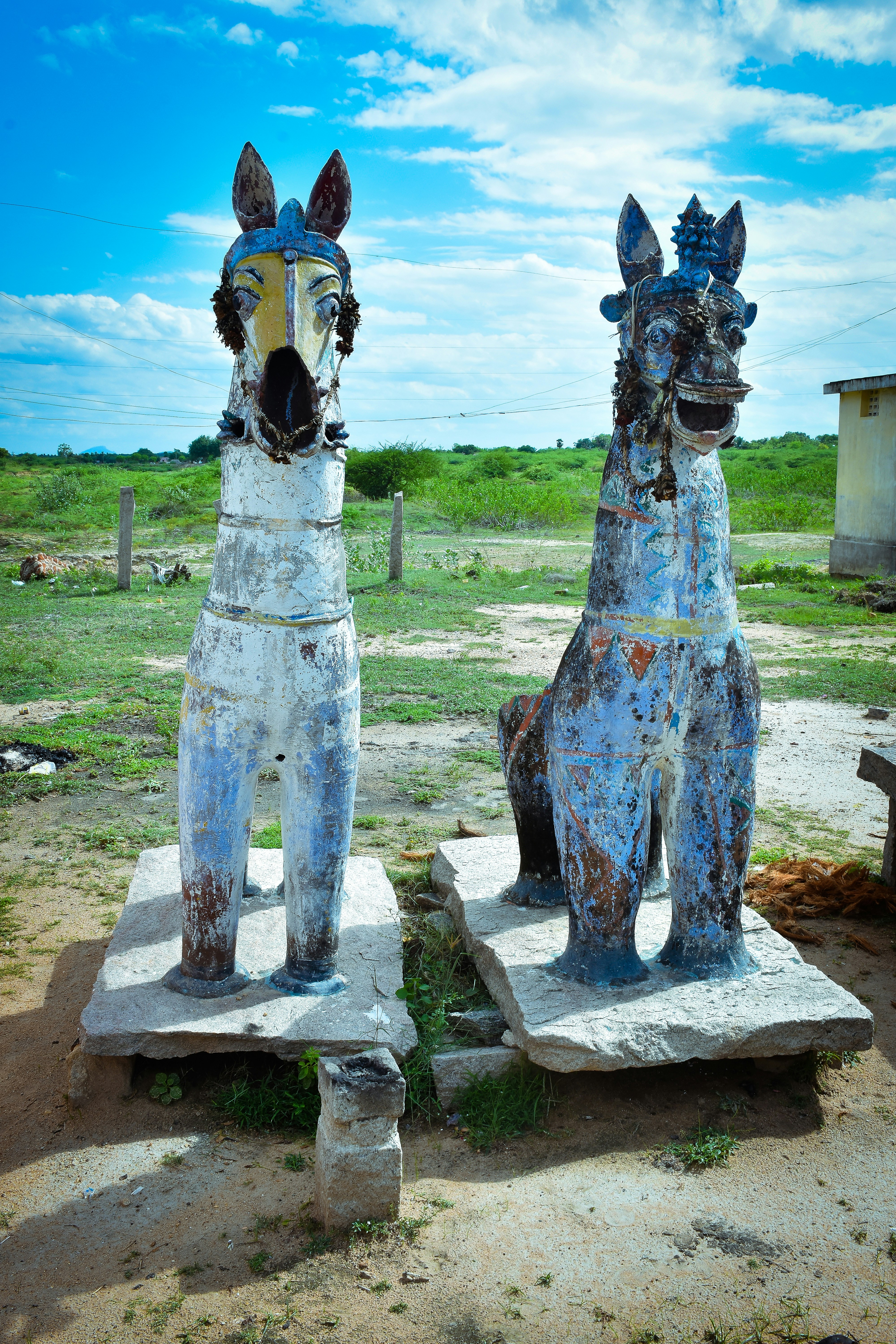 Blue Sentinel Horses on a Cracked Concrete Pedestal