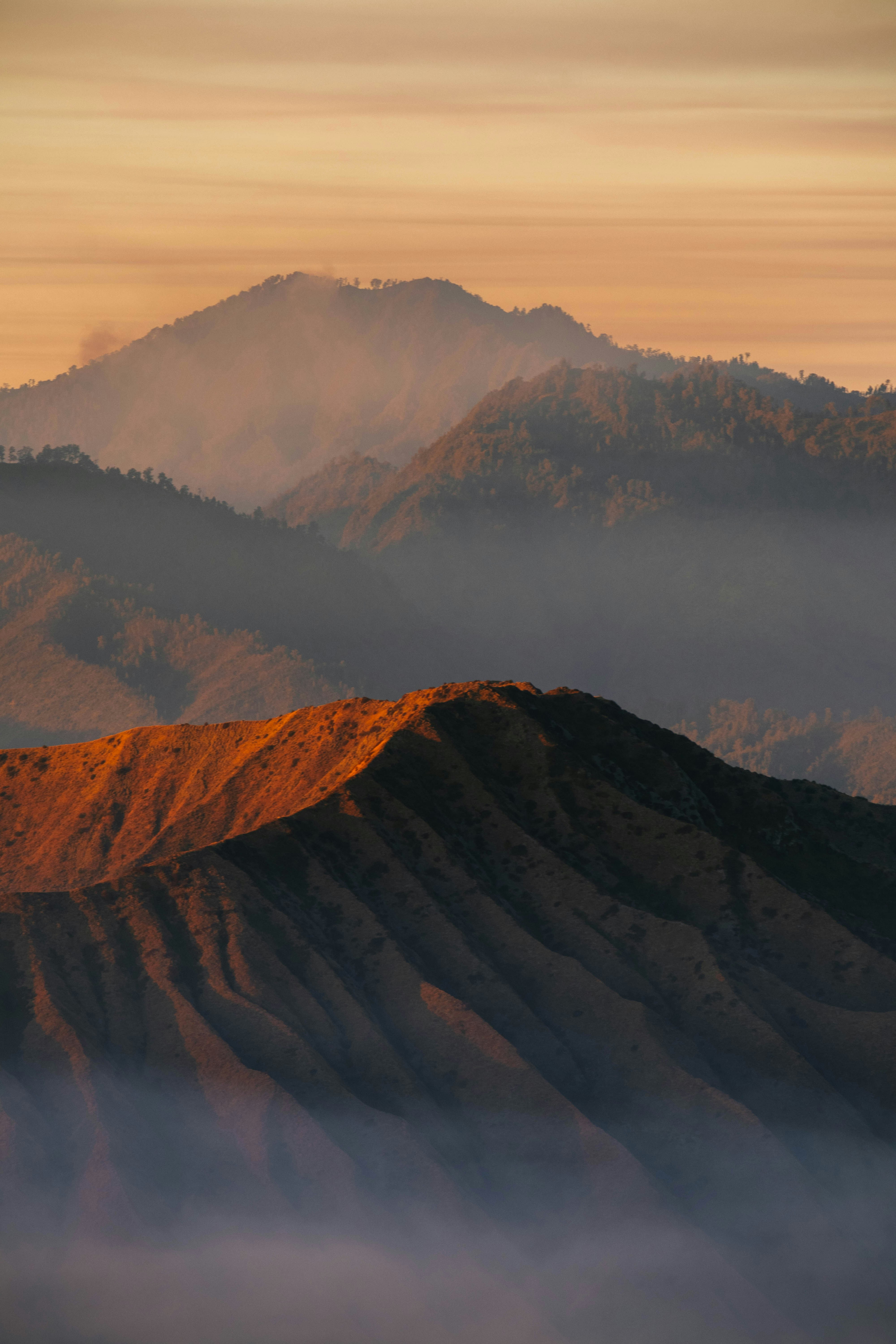 A view of a mountain range covered in fog photo – Free East java Image ...