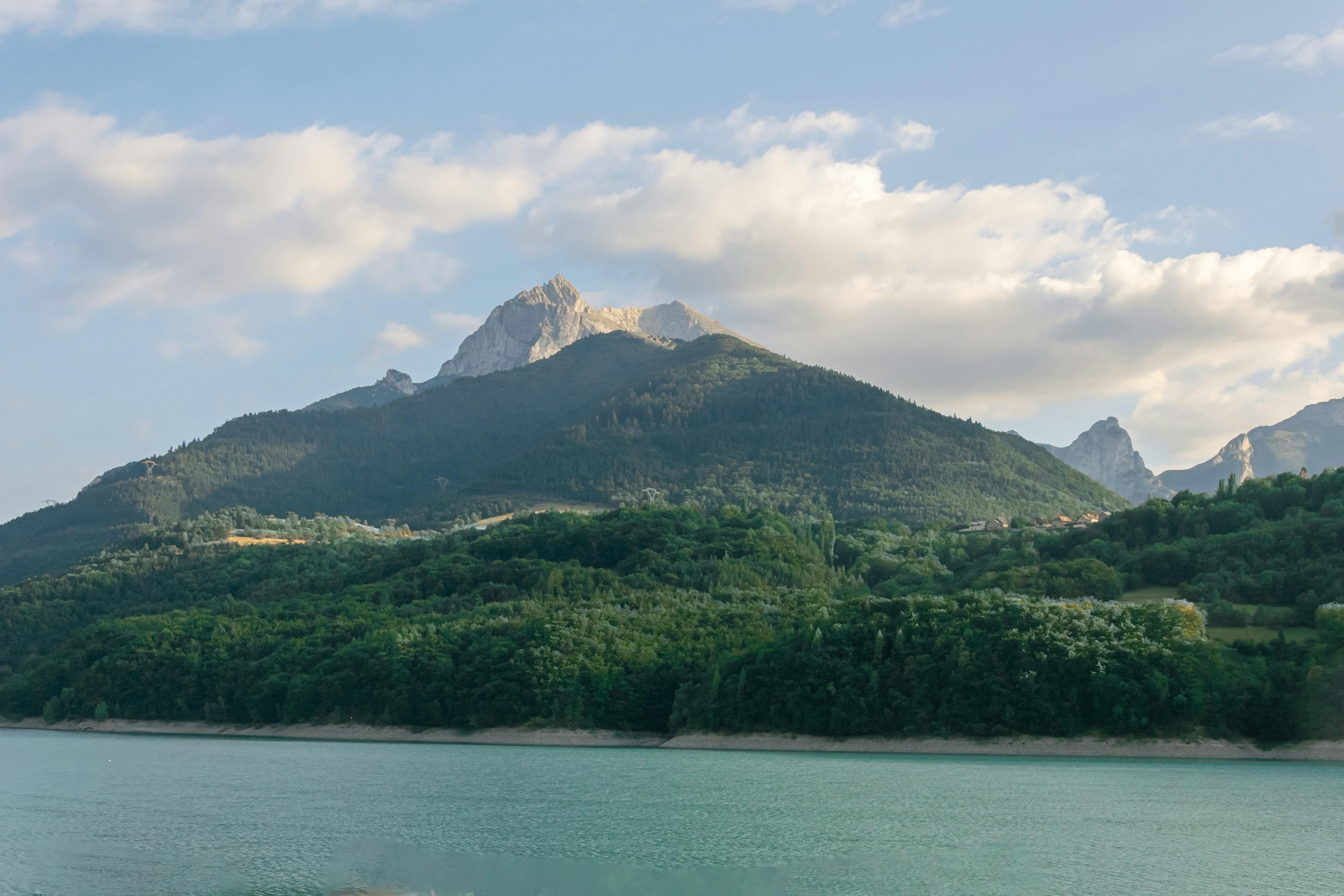 Verdant Ridge and Glassy Lake: Morning Light on a Mountain Crest