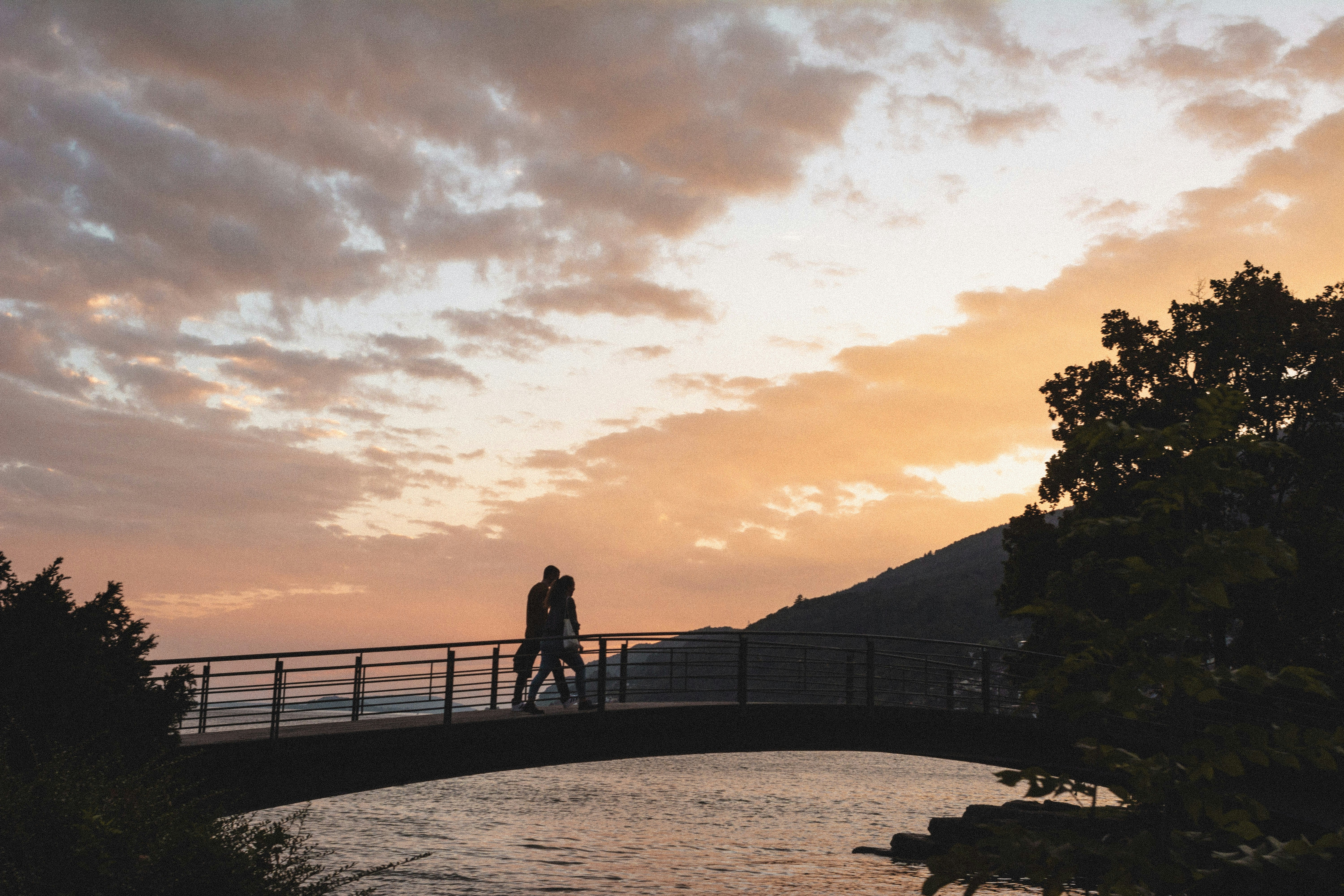 Bridge of Gold: Two Figures in Sunset Silhouettes
