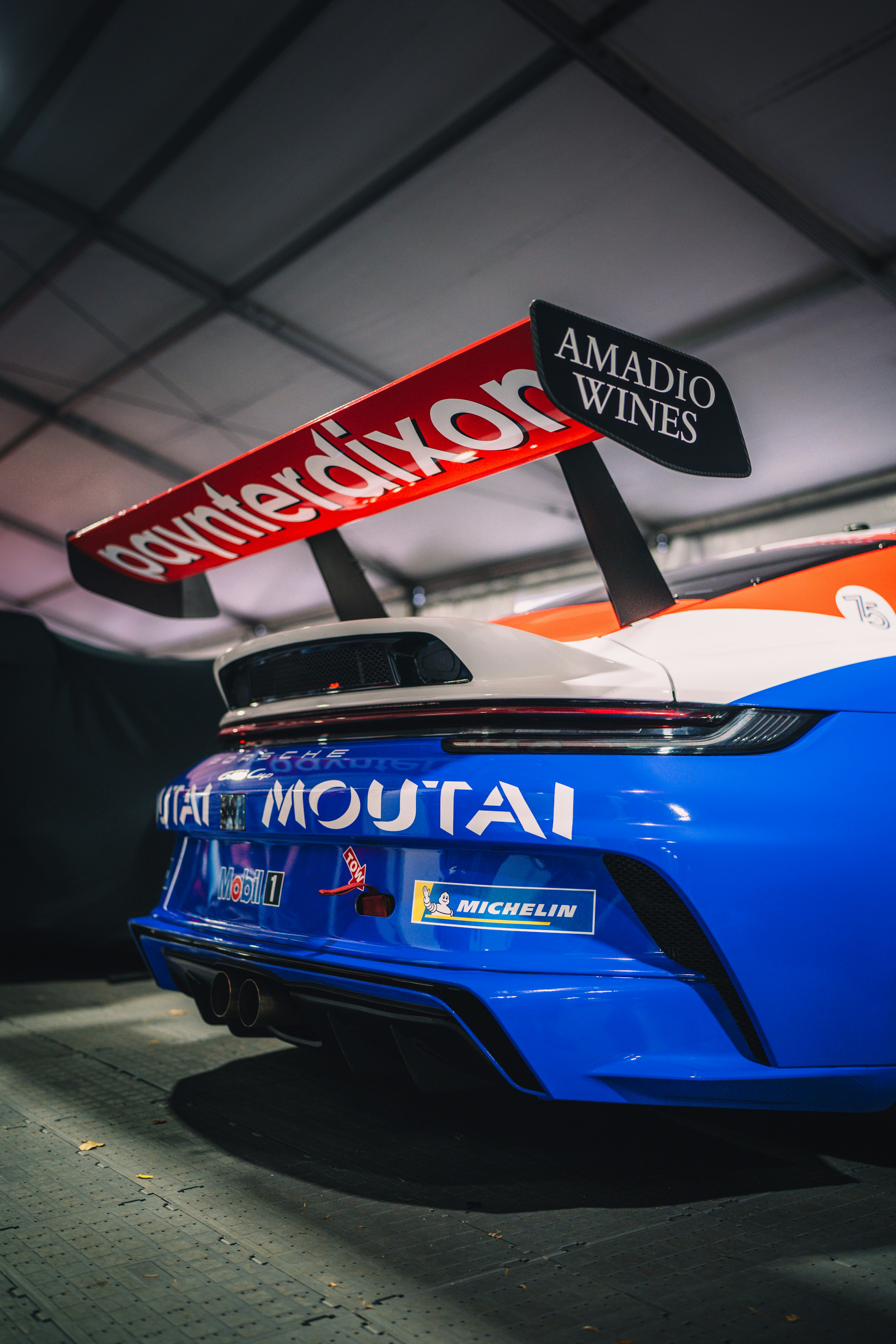 Rear Wing Revelation: Blue Racing Livery Under Indoor Lights