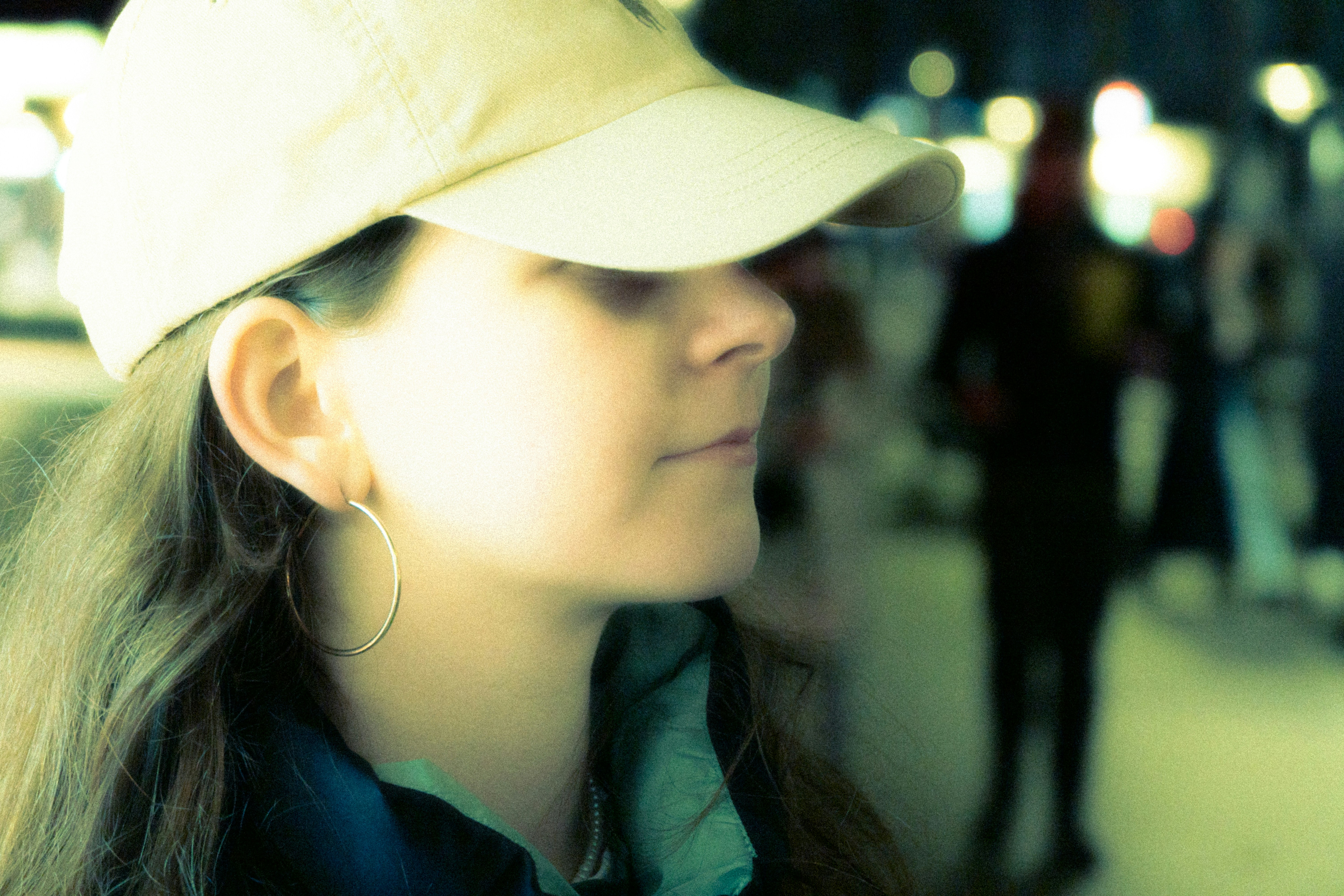 Neon Quiet: A Side Profile Amid City Light Blur