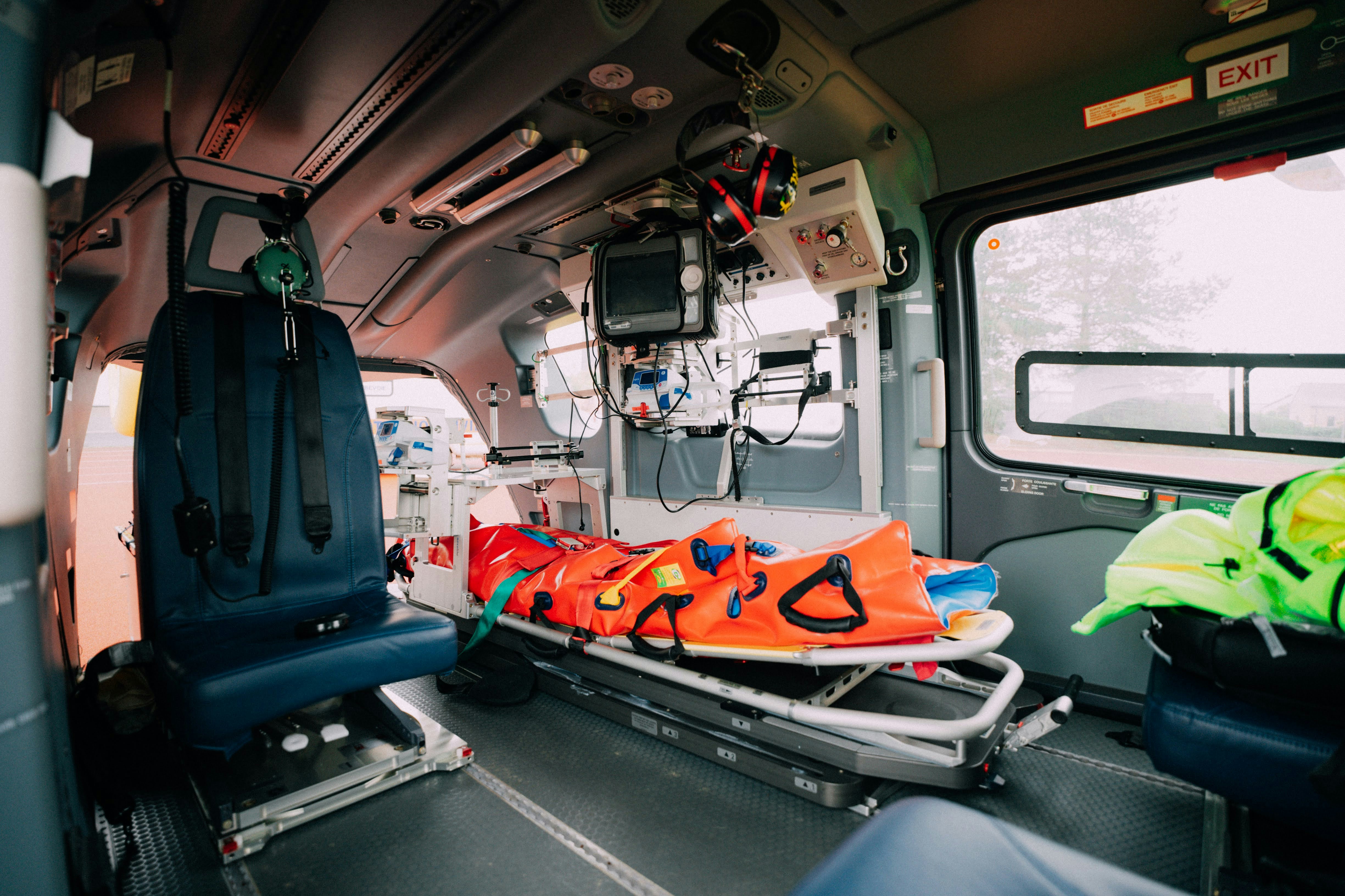 An ambulance with a stretcher attached to the back of it photo – Free ...