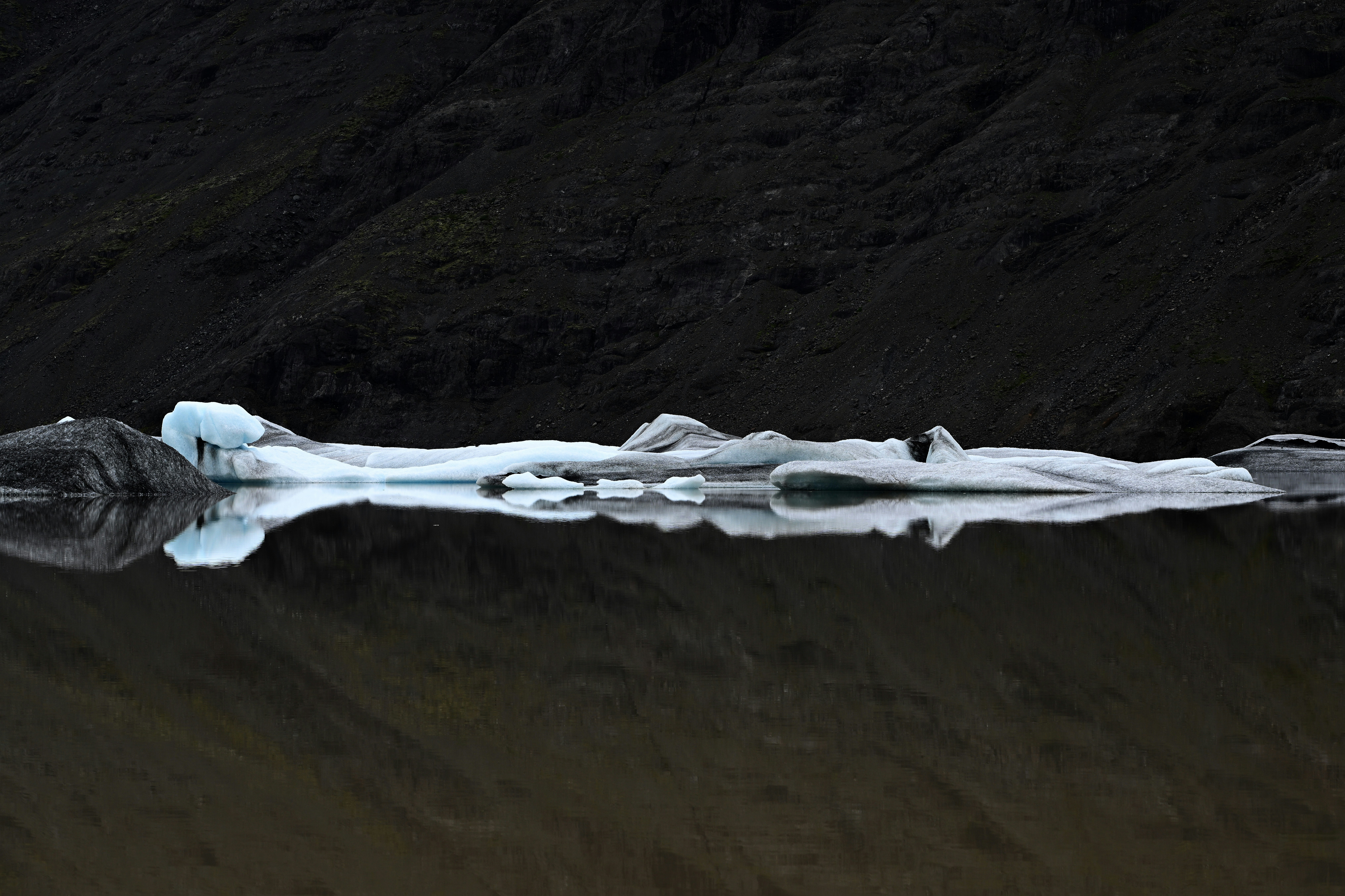 a large iceberg floating on top of a lake