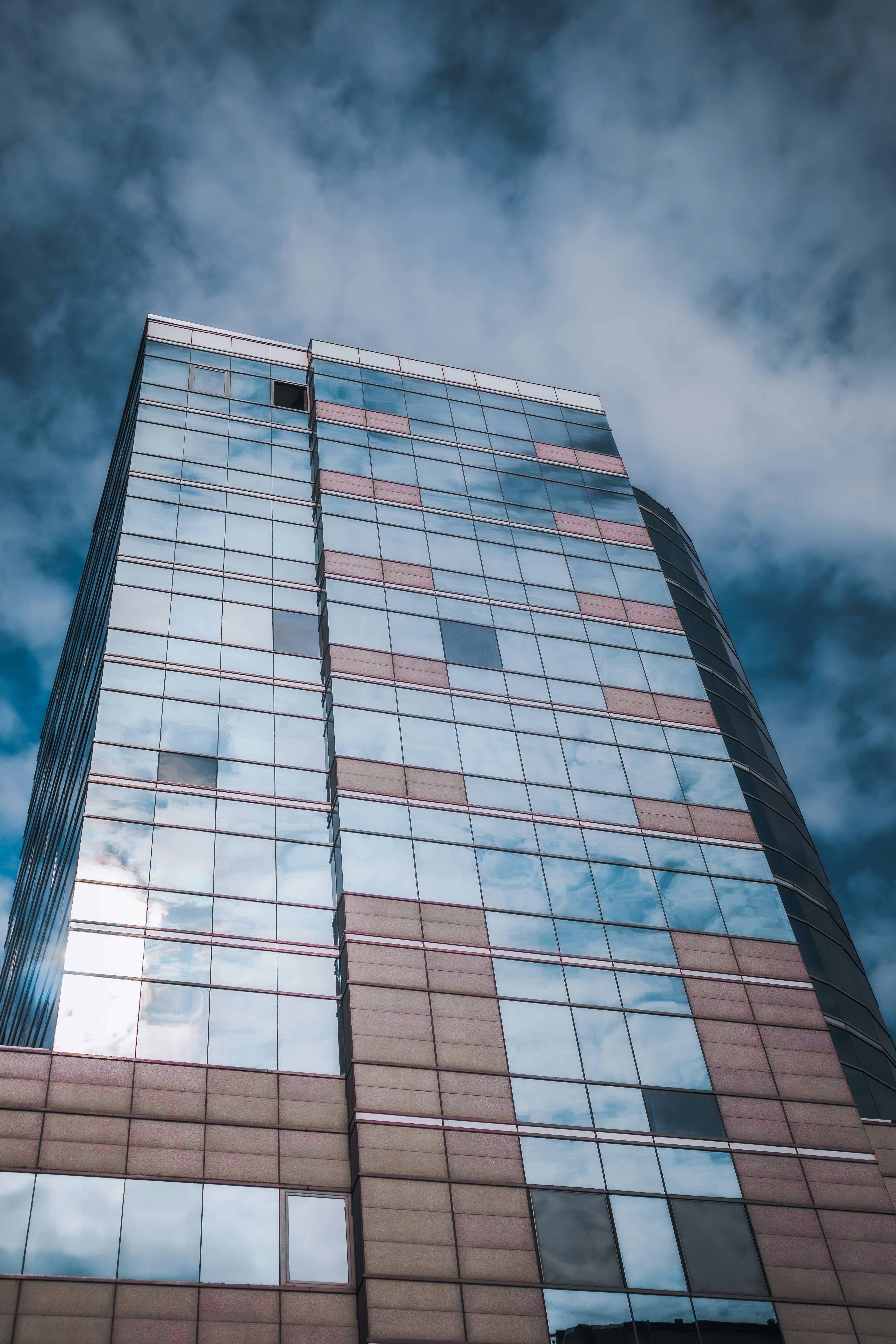 Tilted Glass Beacon: Mosaic Panels Reflect Sky on a Modern Tower