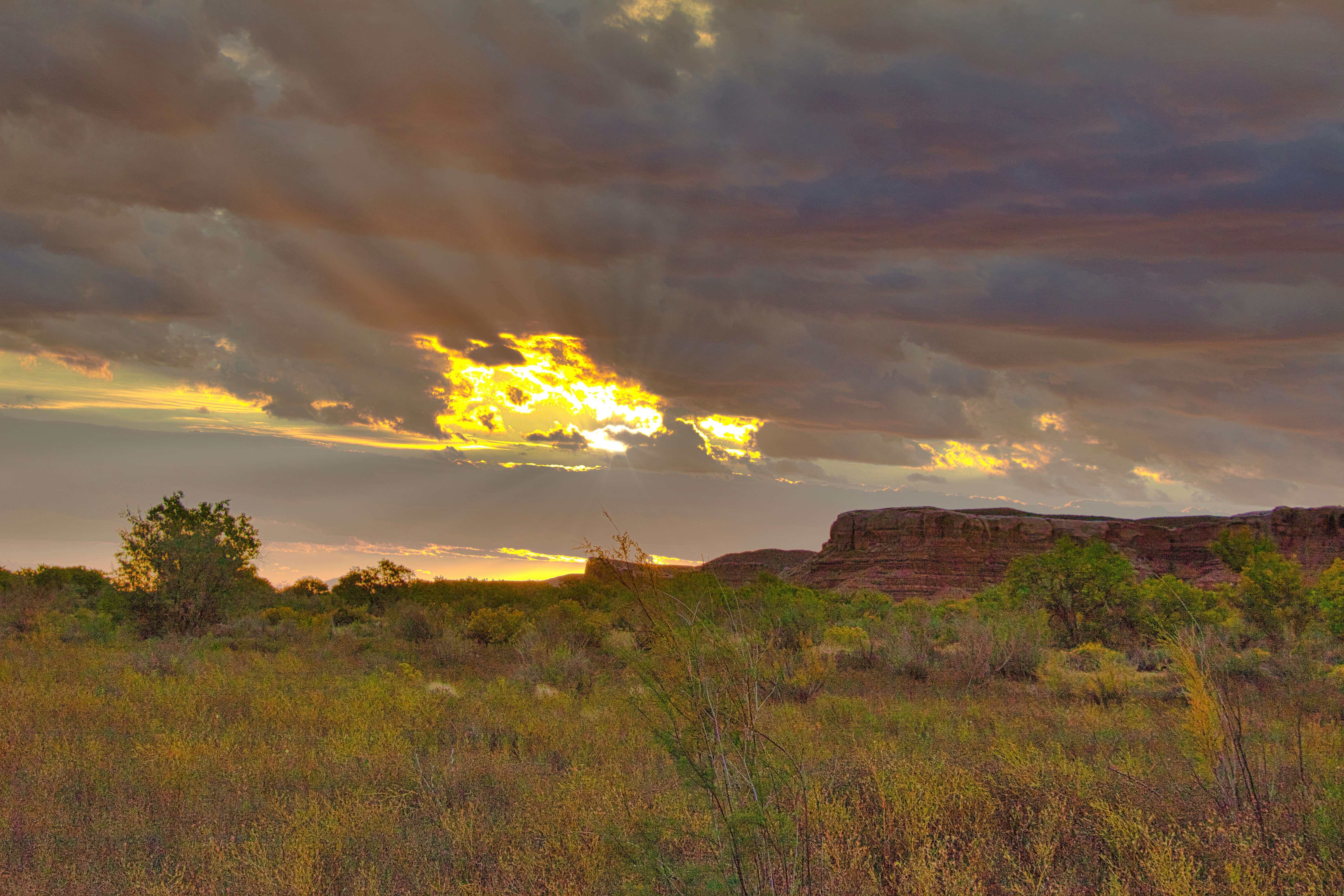 The sun shines through the clouds over the desert photo – Free Ut Image ...