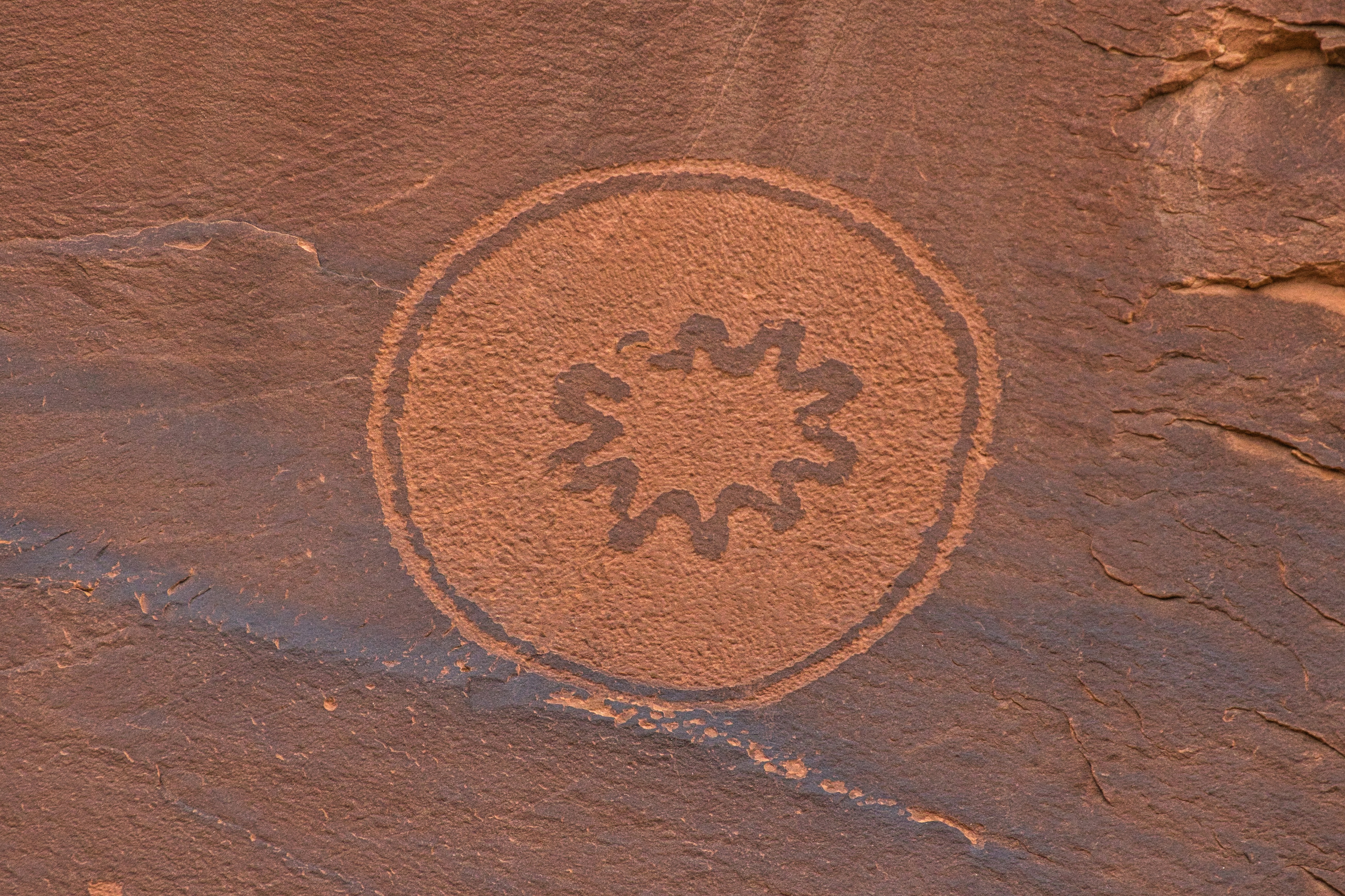 Circular Sun Glyph Carved in Weathered Sandstone