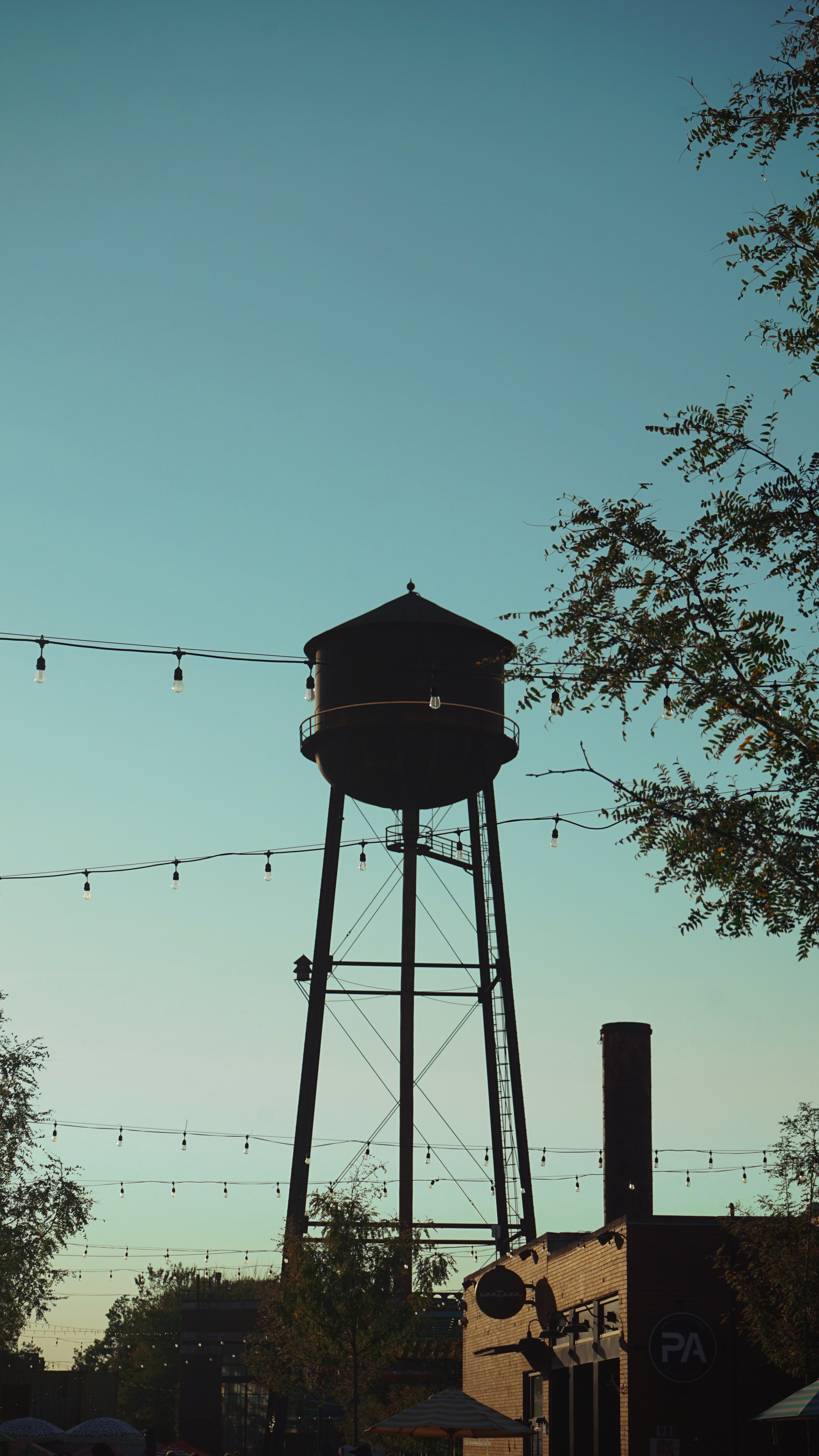 Water Tower Silhouette Under a Sky of Festoon Lights