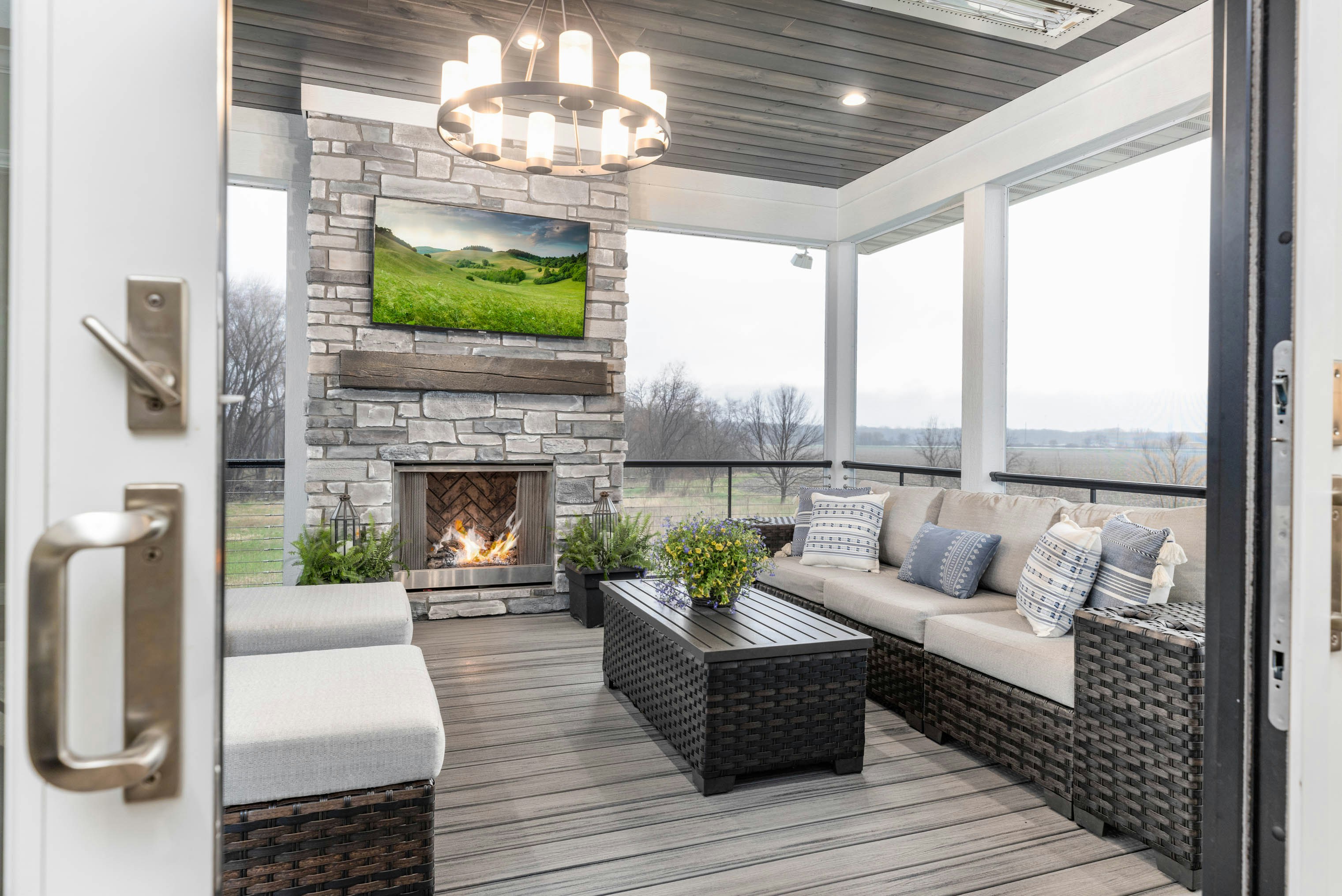 Stone Hearth Amid Glass Walls: A Cozy Porch Retreat