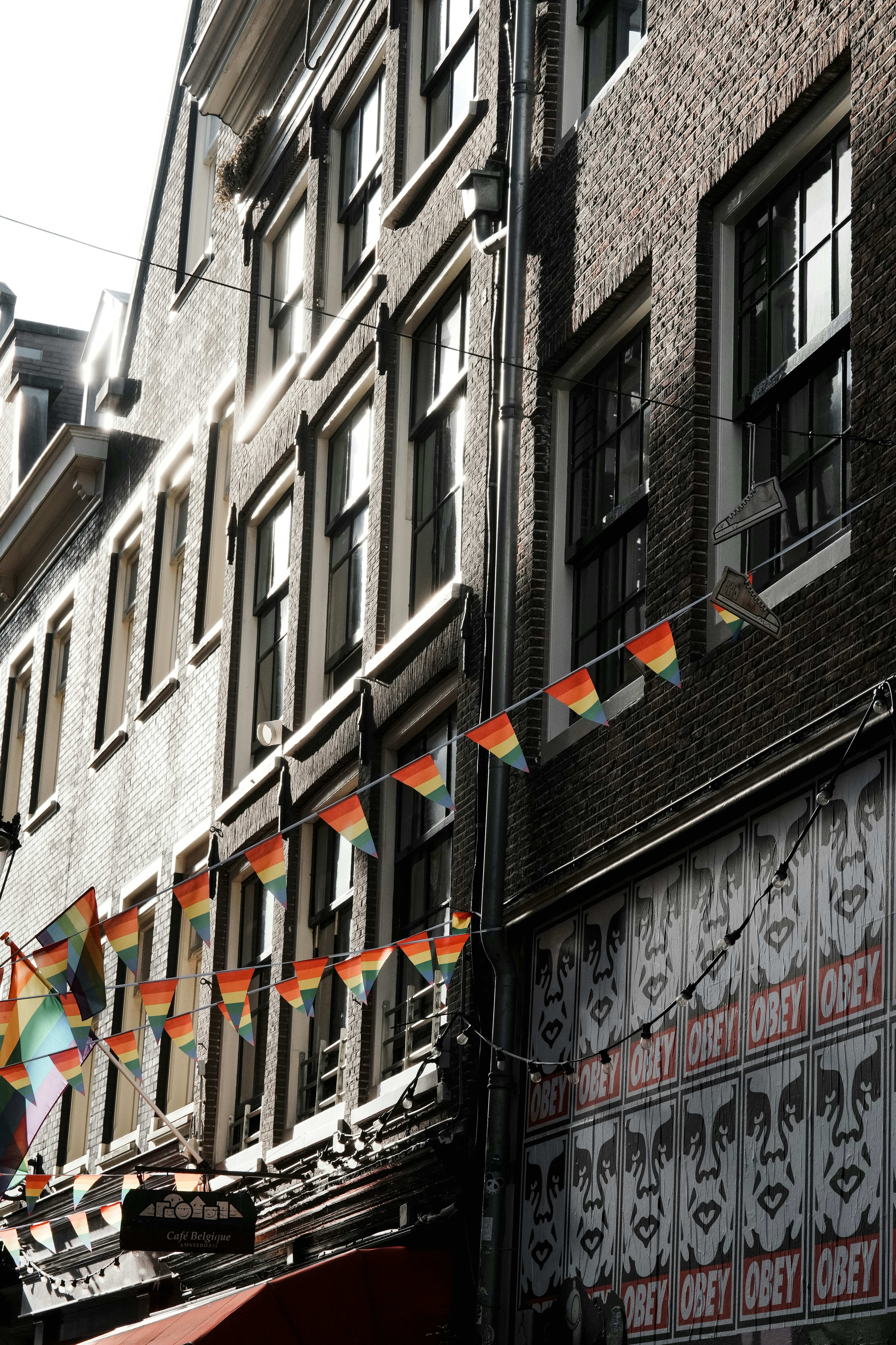 Bunting Over Brick: An Alleyway’s Colorful Interlude with Obey Murals