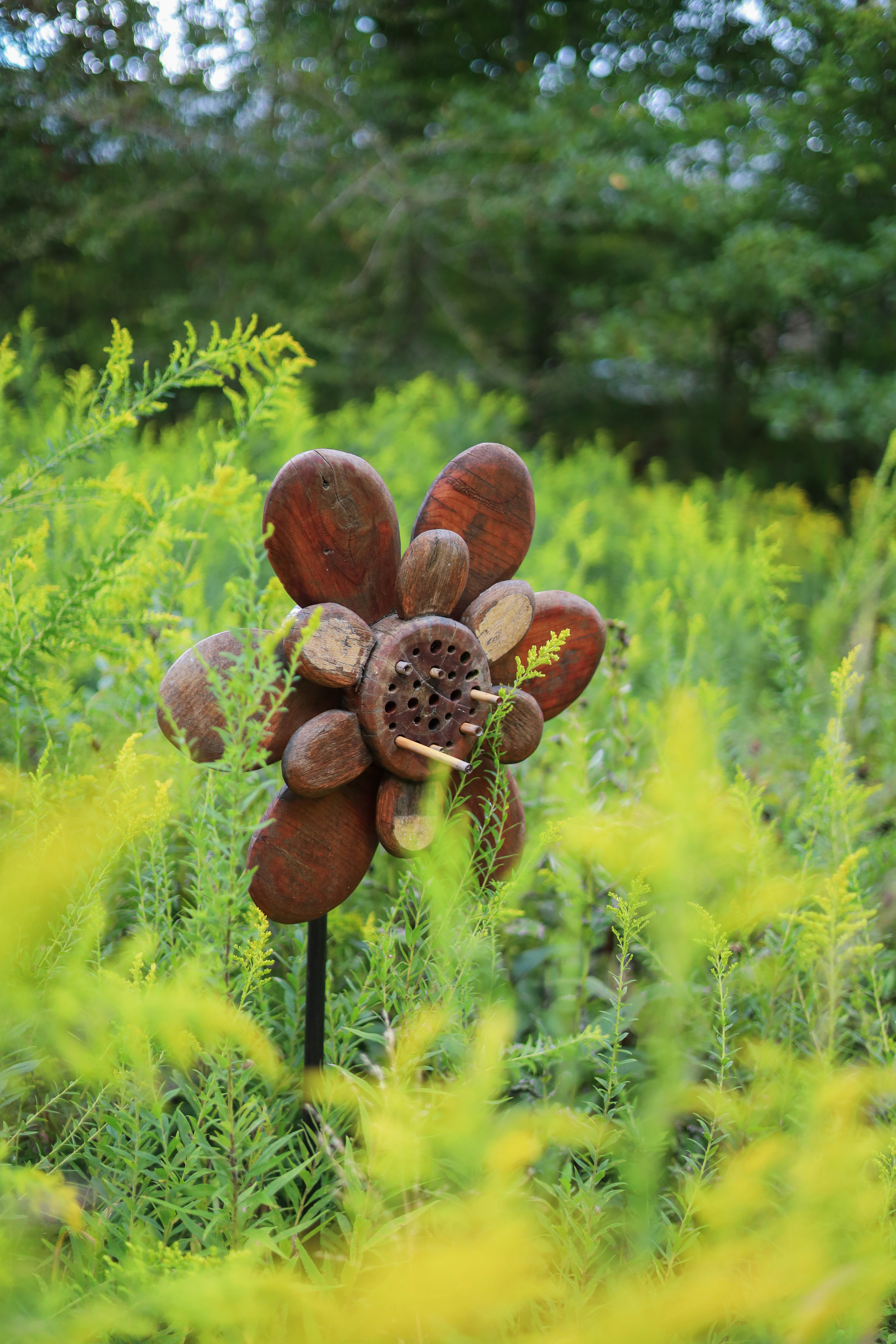a metal flower in a field of tall grass
