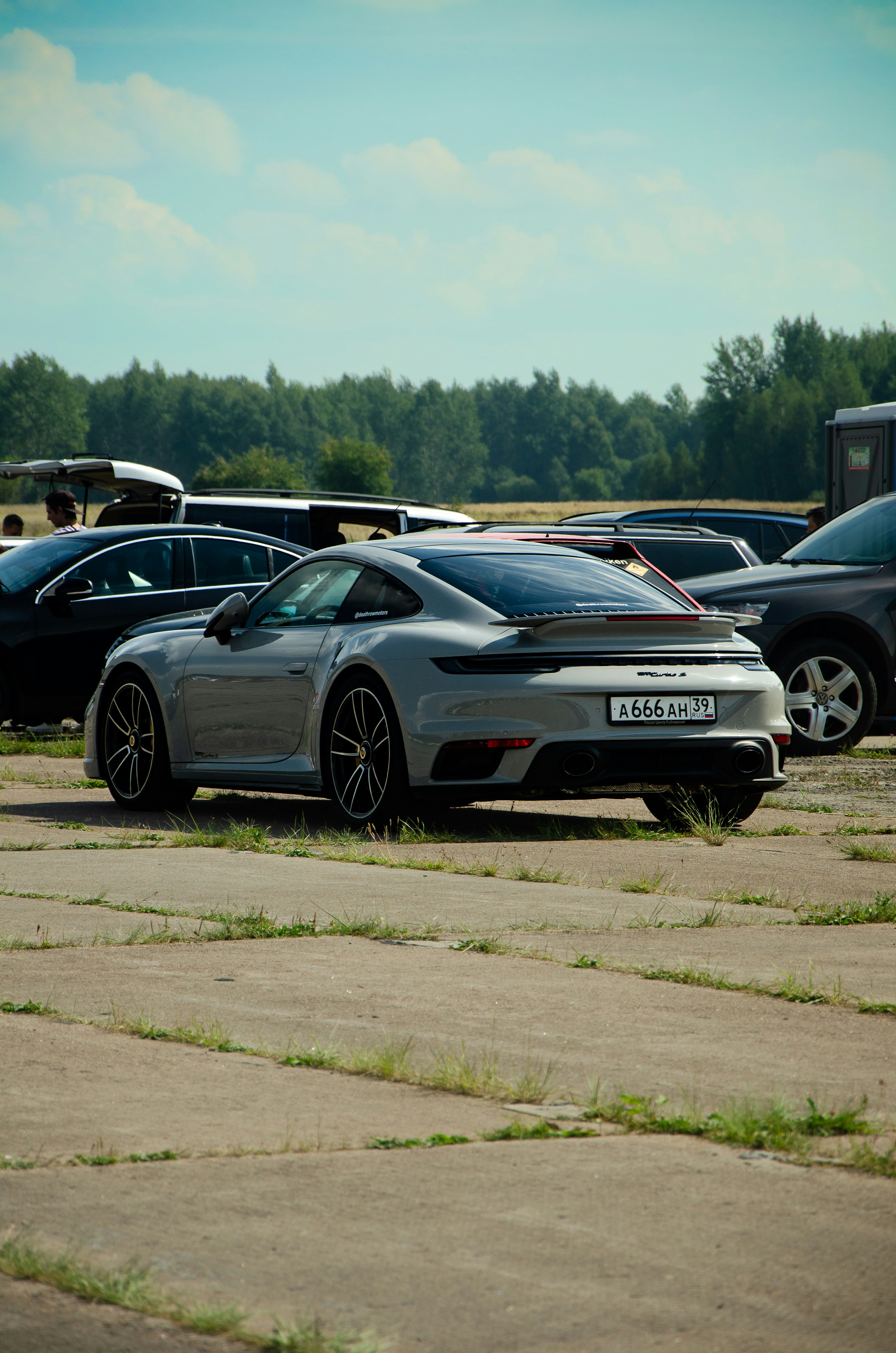 Grey Porsche Stands Quietly Among Parking Lot Echoes