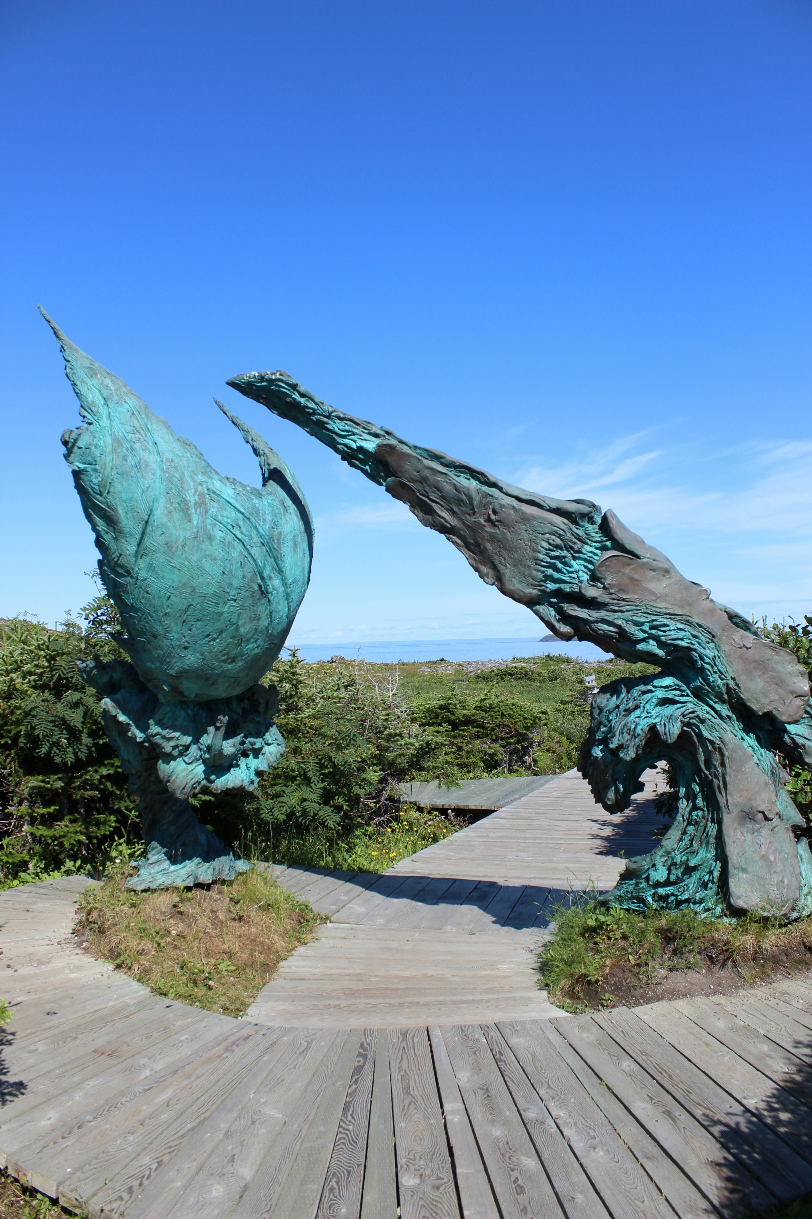 Bronze-green Sails Over a Seaside Boardwalk