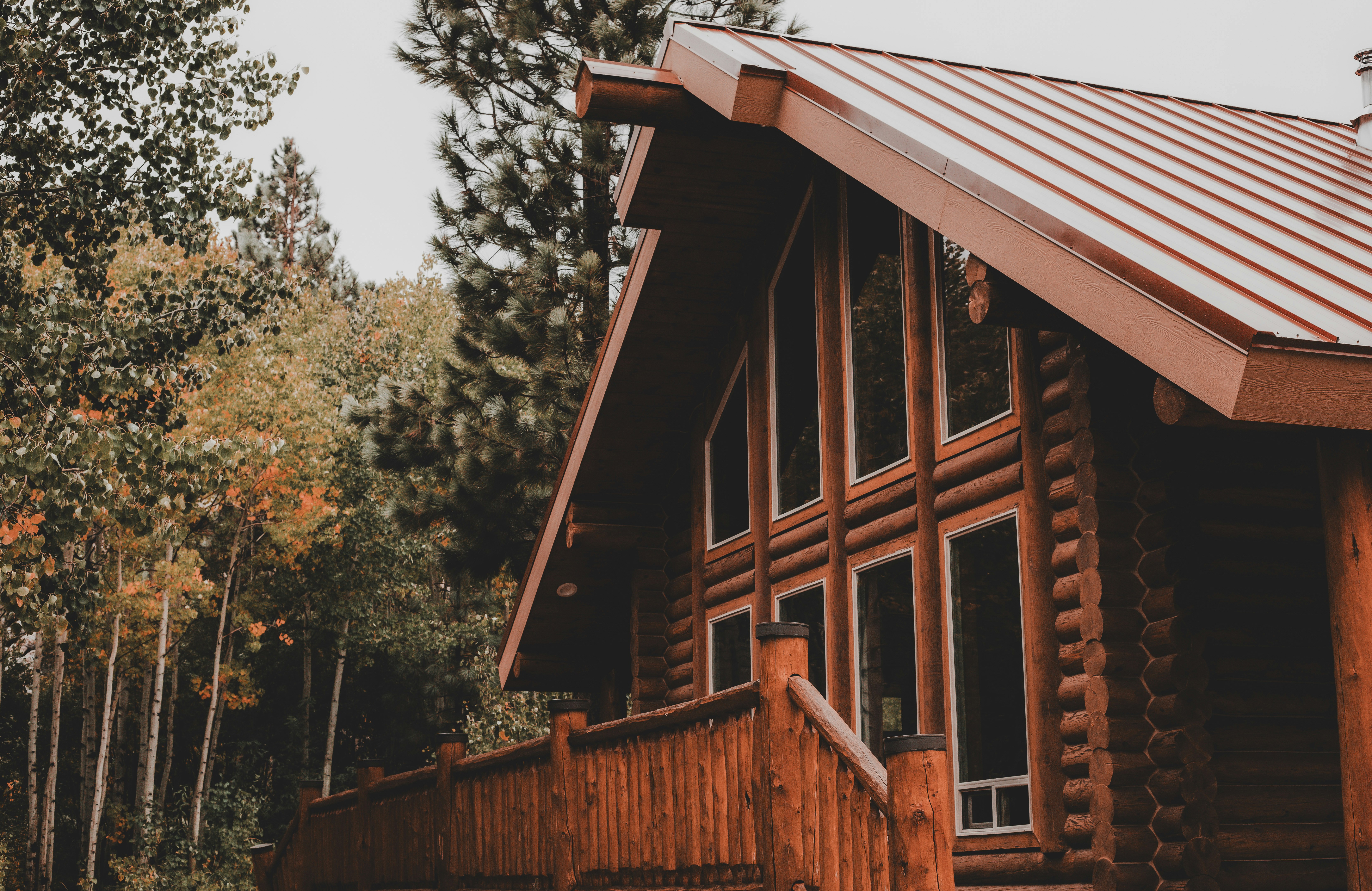 A log cabin with a metal roof and a red tin roof photo – Free Building ...