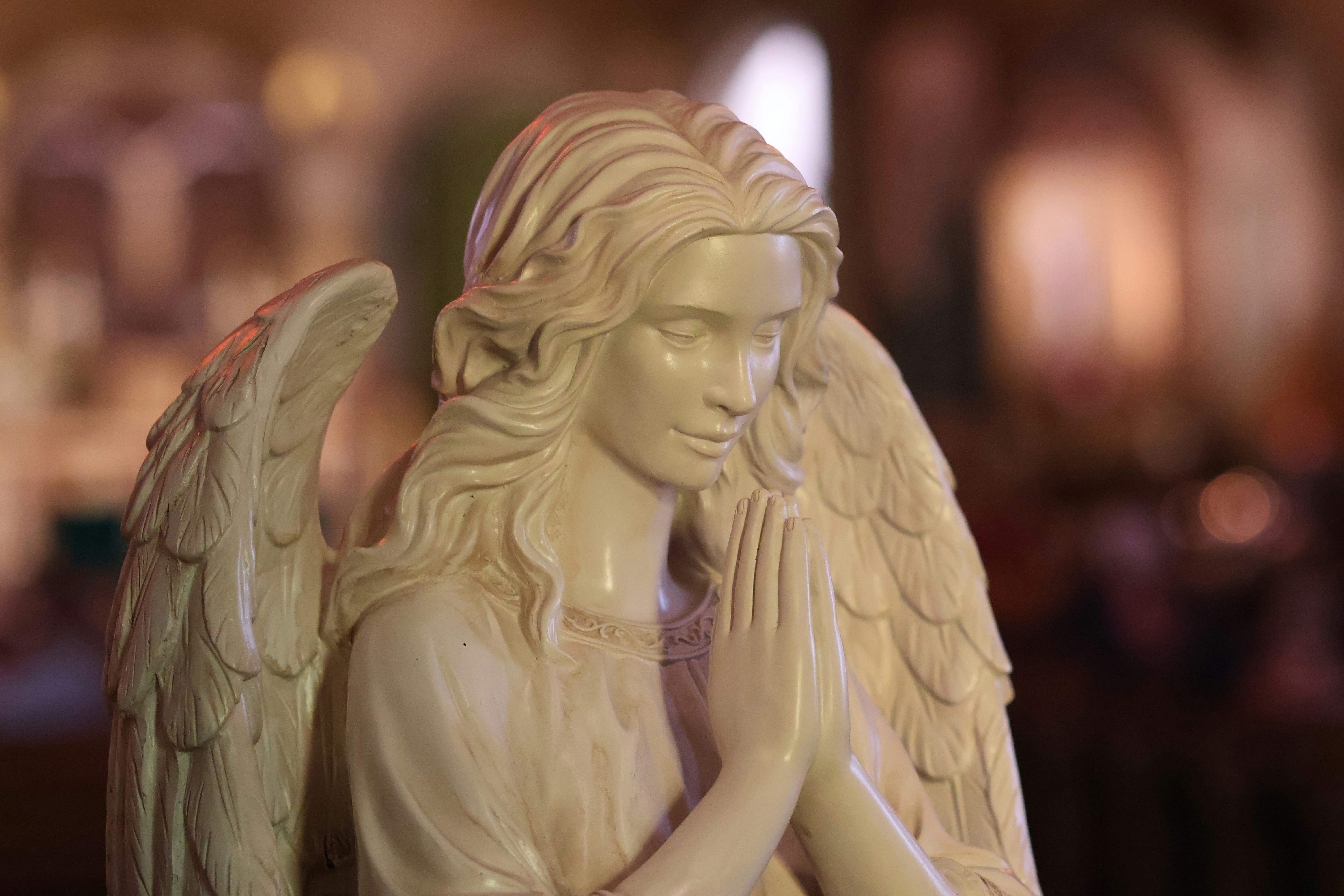 A statue of a praying angel in a church photo – Free Angel Image on ...