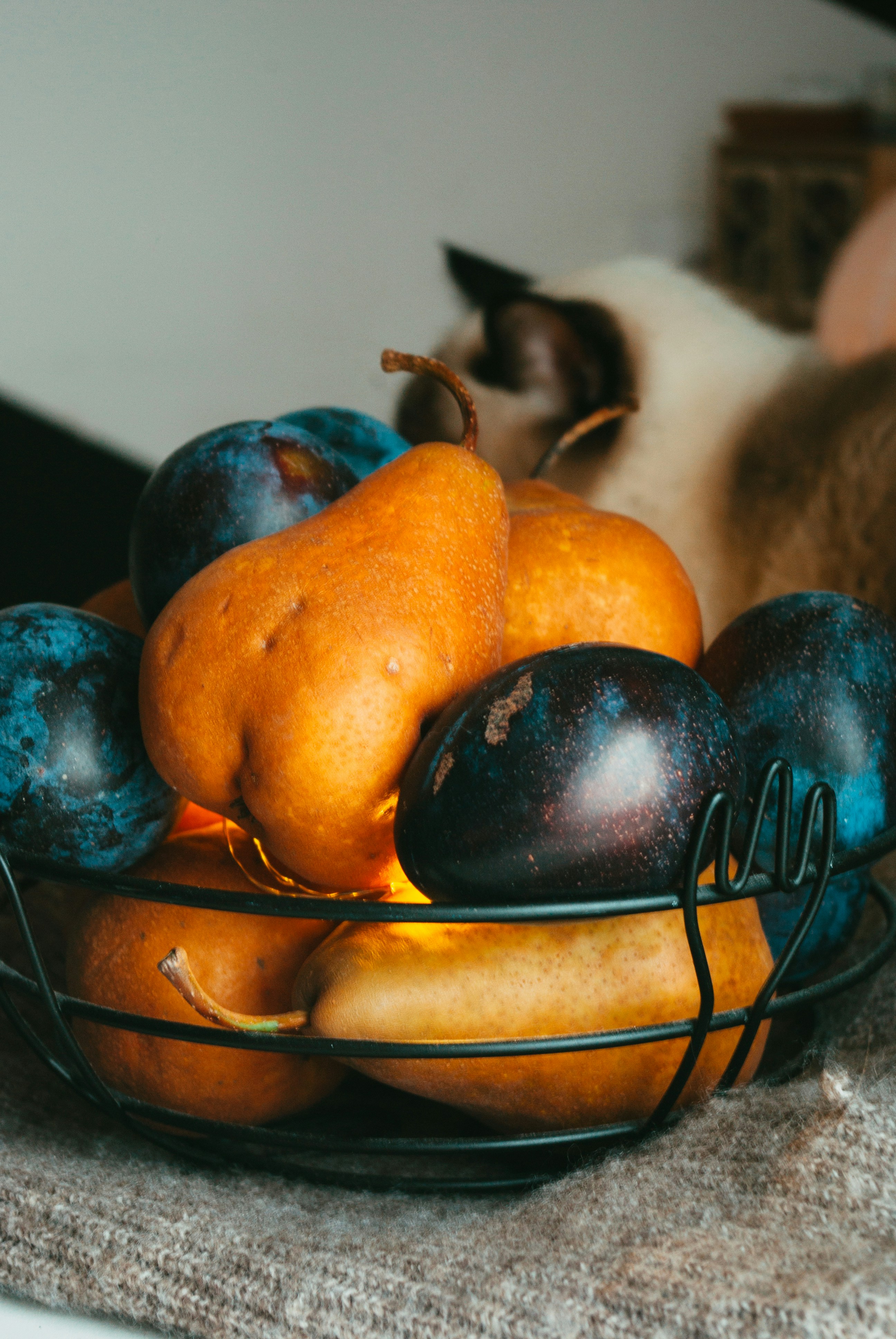 a basket filled with fruit sitting on top of a table