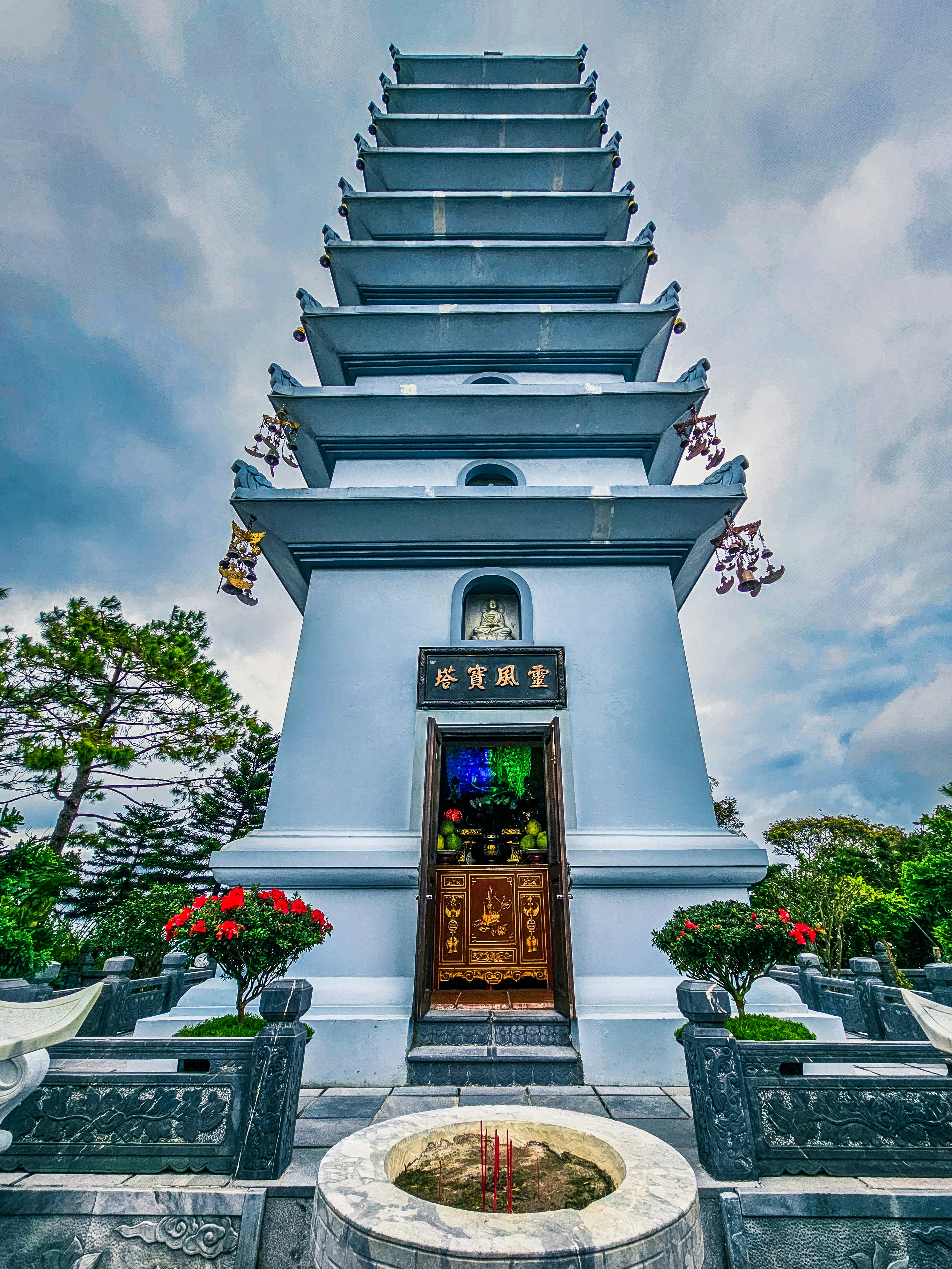 Ascending Blue Pagoda: A ceremonial tower piercing the clouded sky