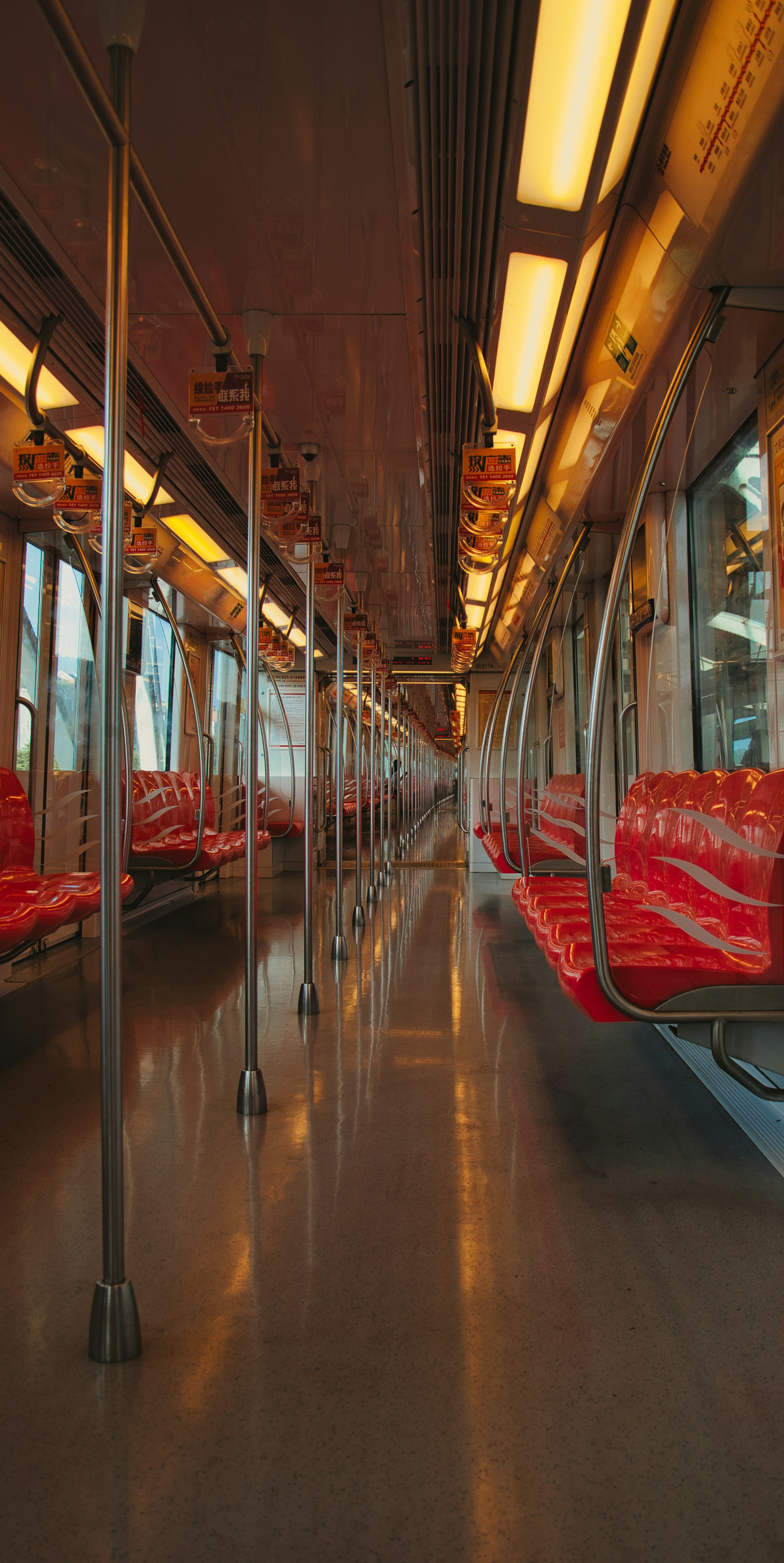 A long empty train car with red seats photo – Free Furniture Image on ...