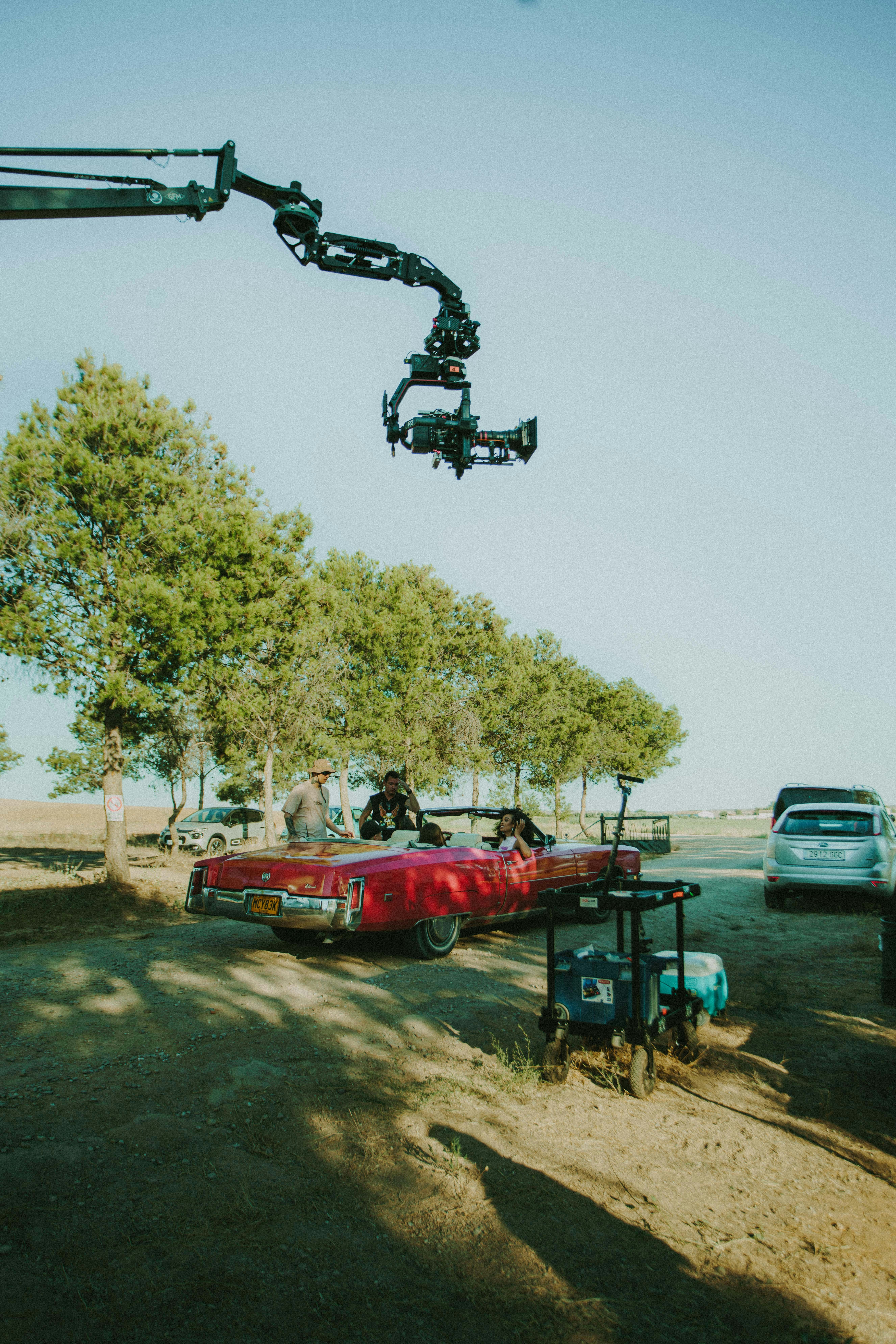 Crane Over the Red Convertible: A Sunlit Outdoor Shoot