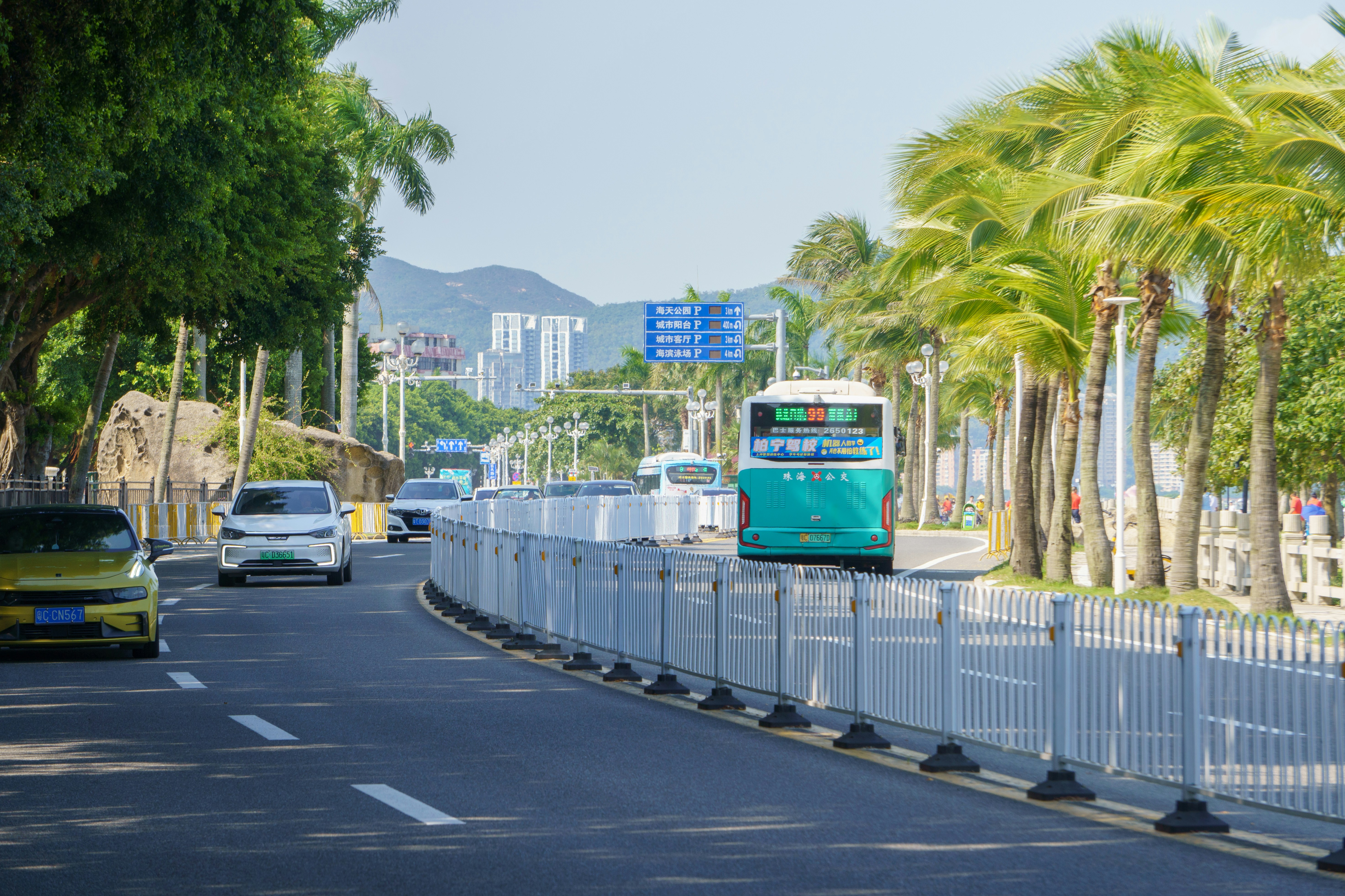A blue double decker bus driving down a street photo – Free City Image ...