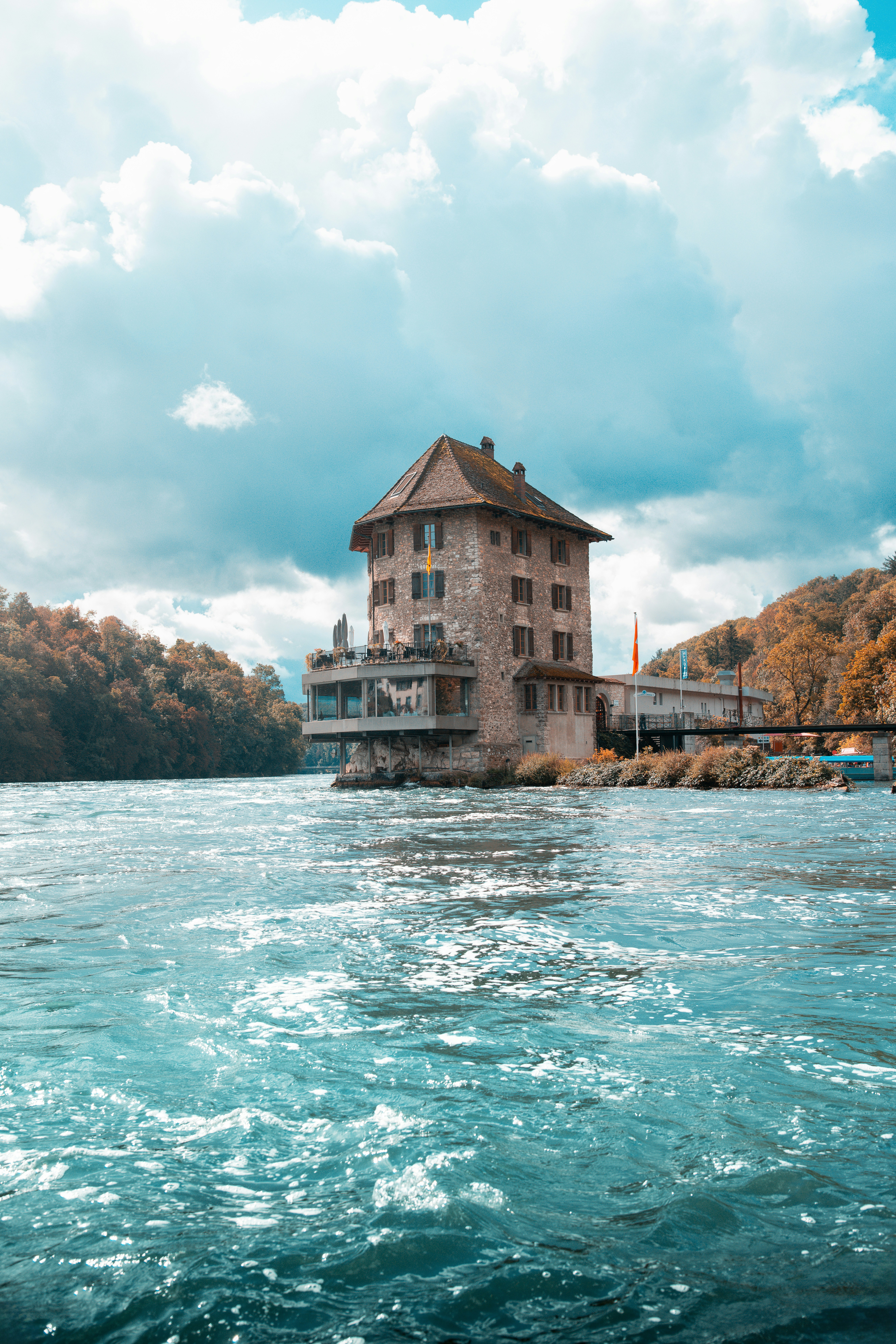 Riverside Keep: Stone Tower Rising Over Turquoise Waters