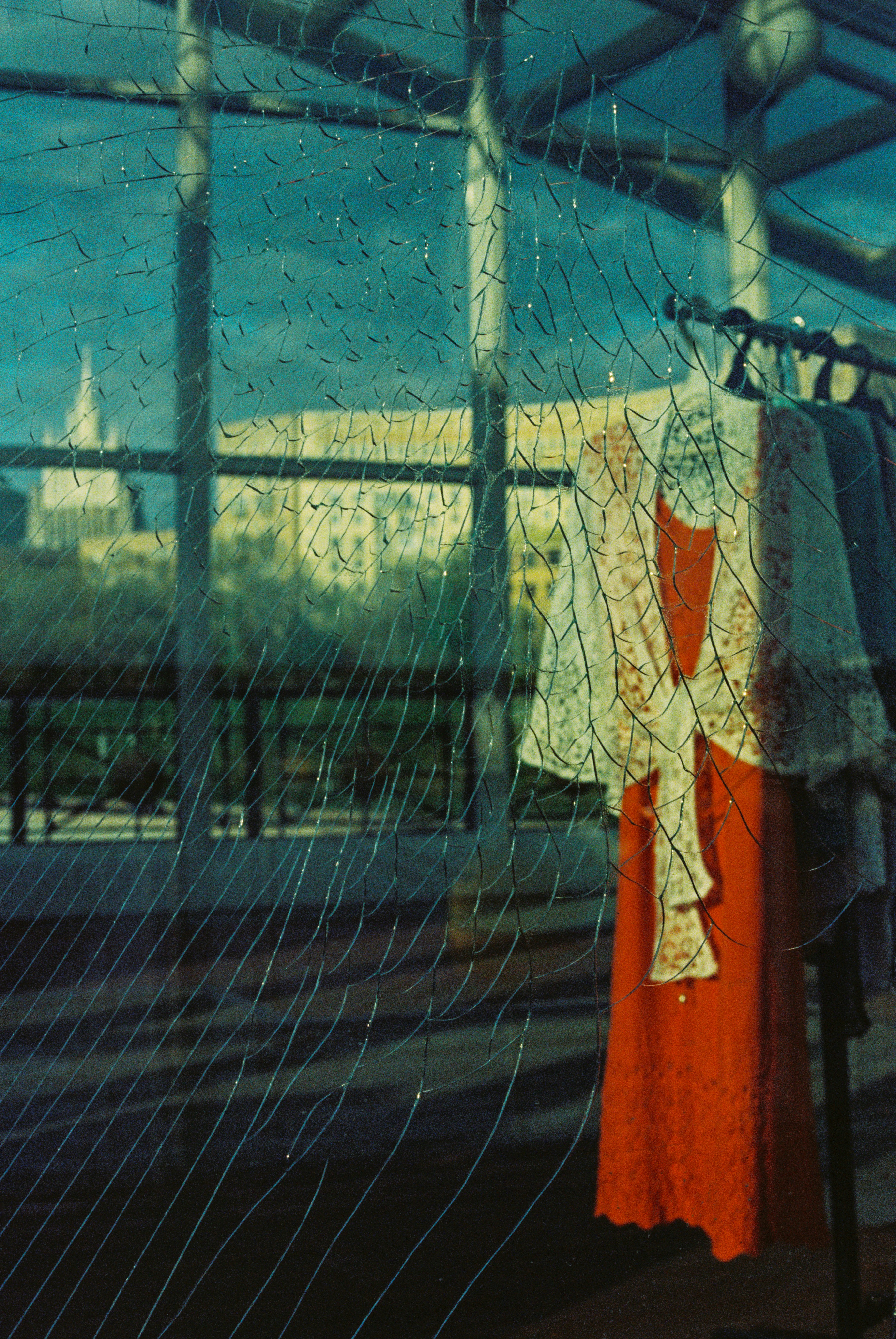 A red dress hanging on a clothes rack photo – Free Dress Image on Unsplash