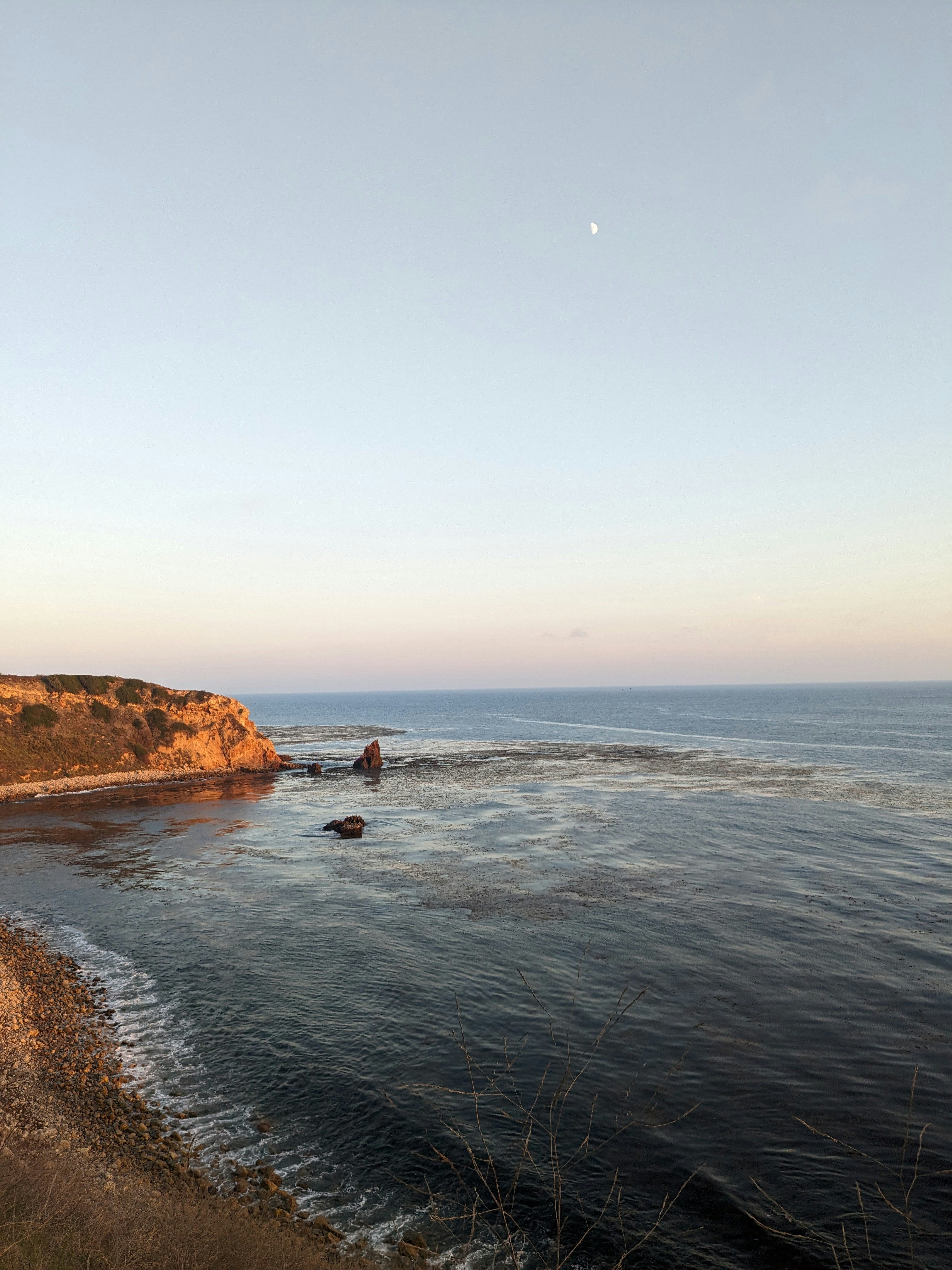 Sunlit Cliff Edge Over a Quiet Seascape at Dusk