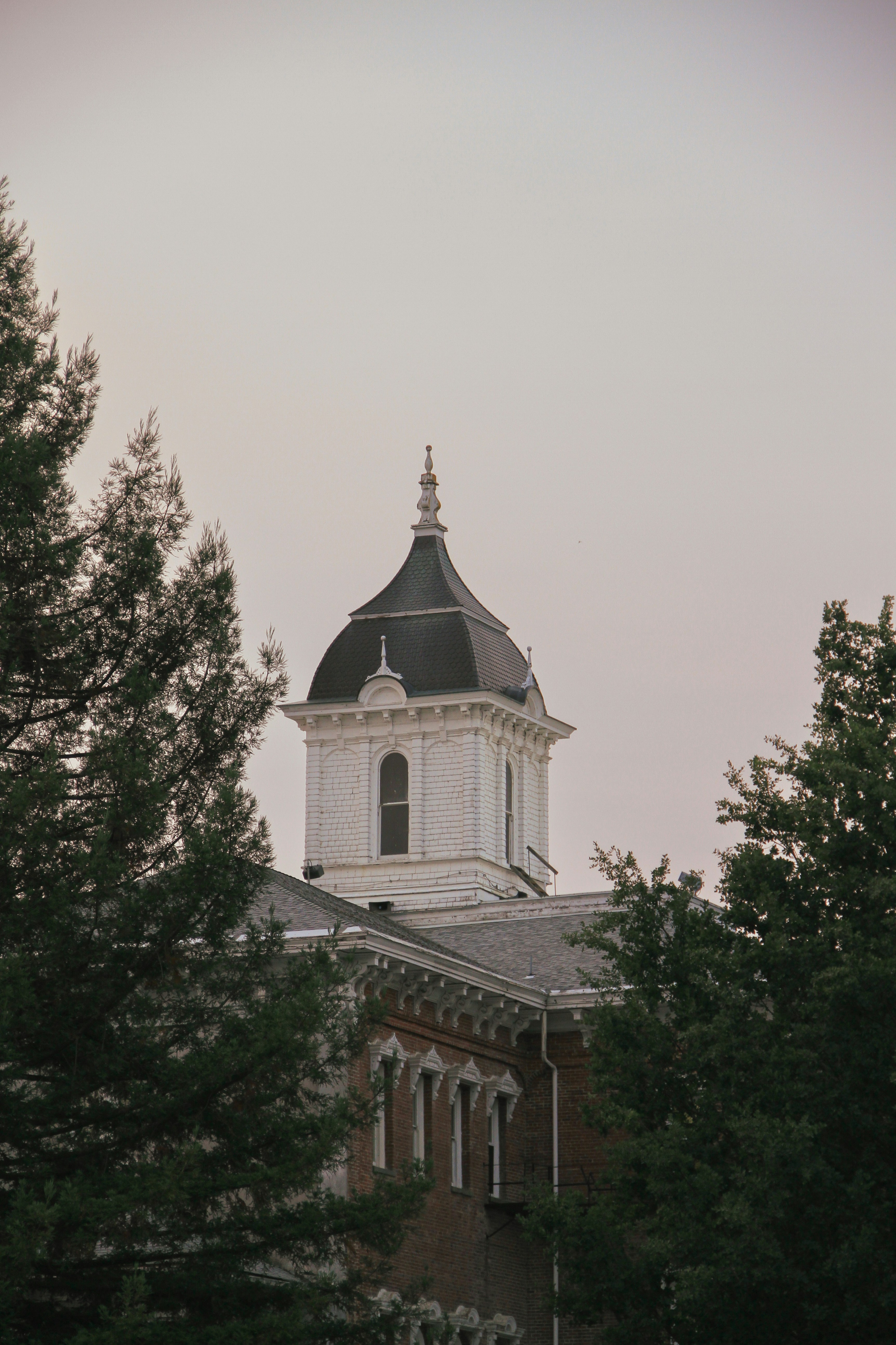 A building with a clock on the top of it photo – Free Linfield ...