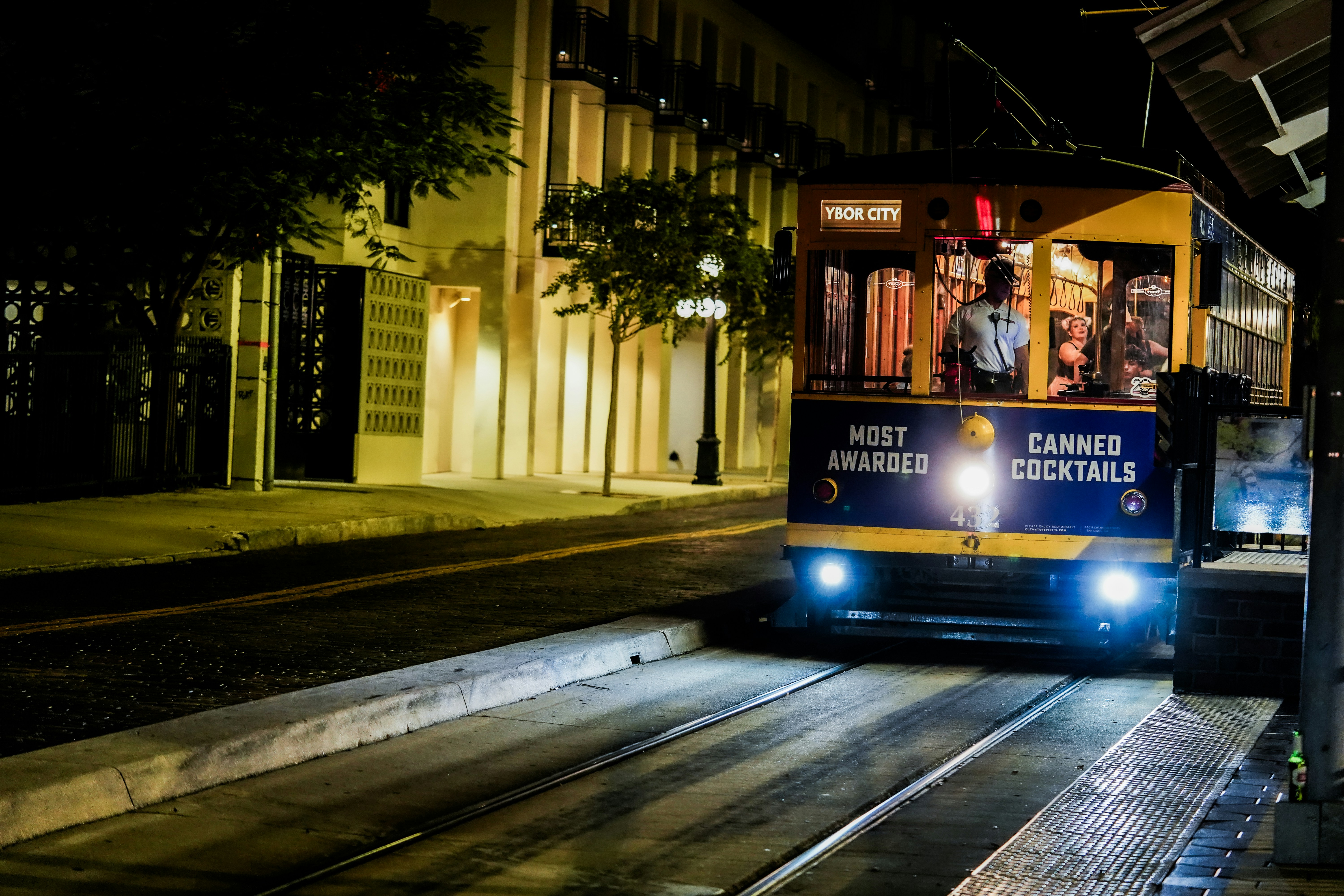 a trolley on a city street at night