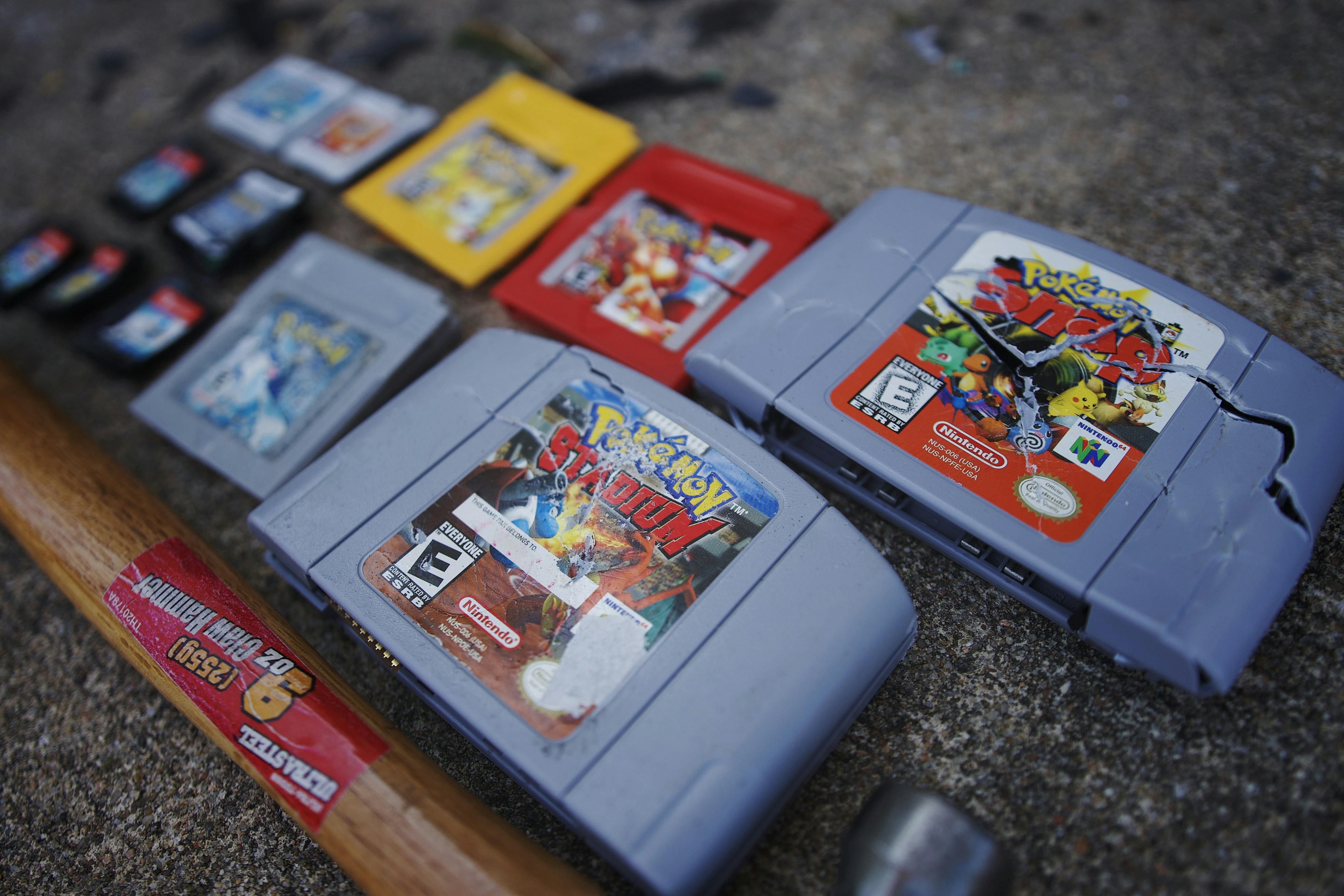 A group of nintendo games sitting next to a baseball bat photo – Free ...