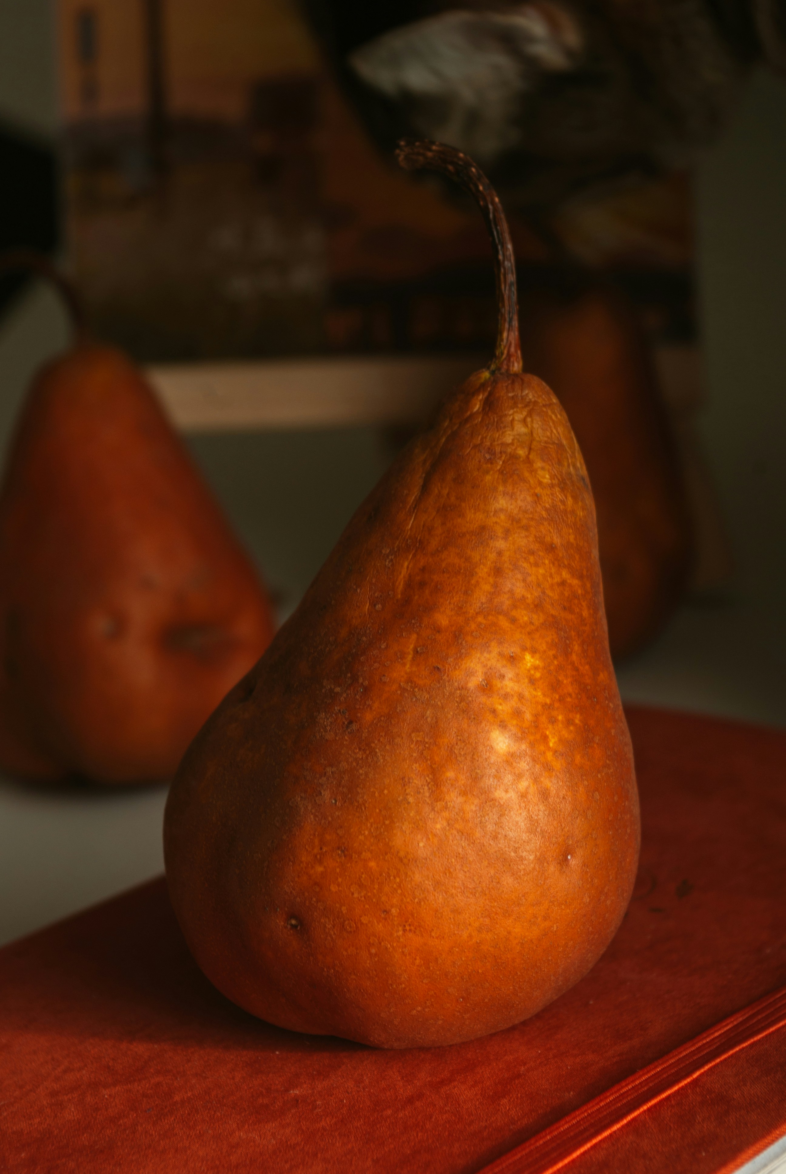 Ember-Hued Pear Under a Quiet Copper Glow