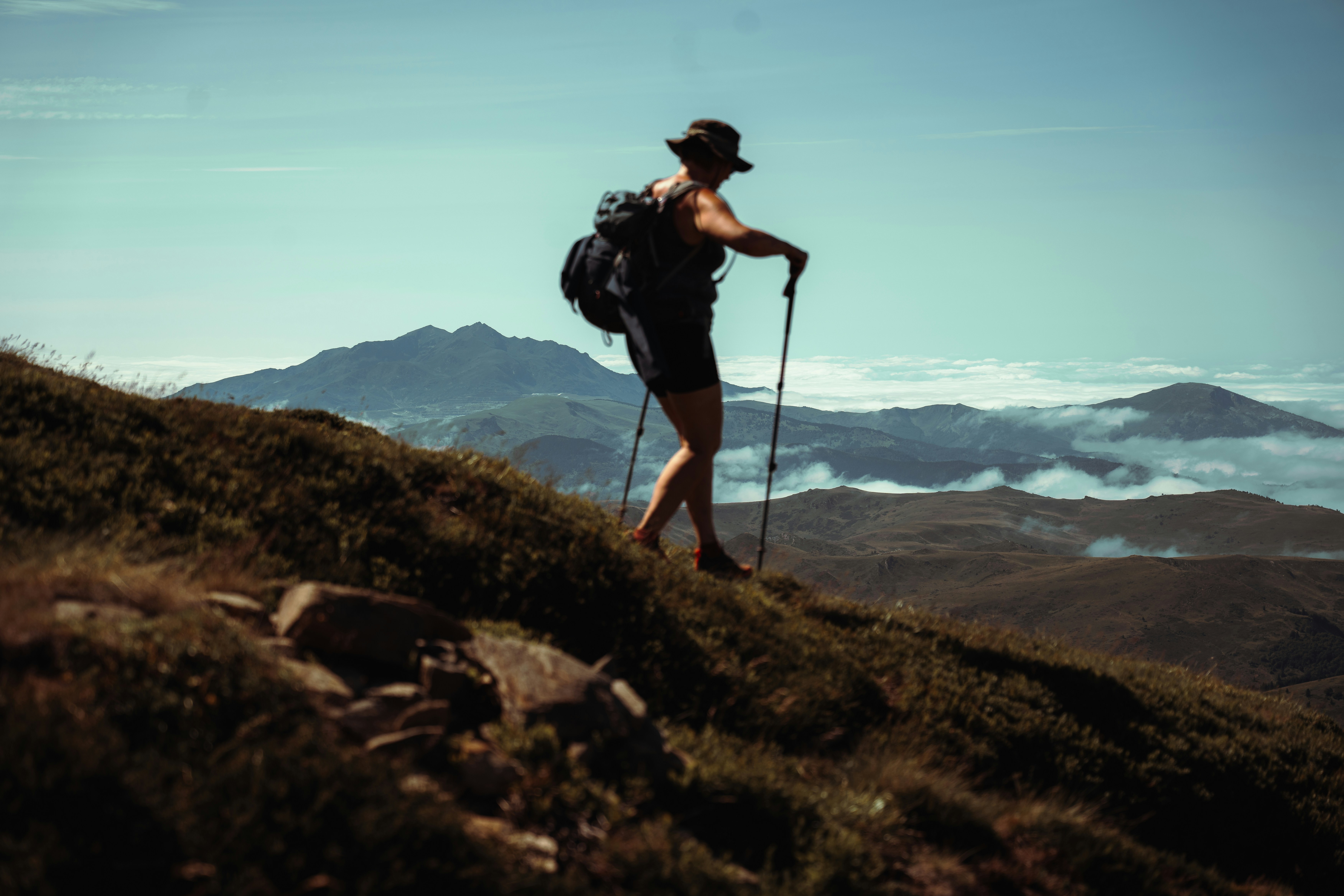 A man hiking up a hill with a backpack photo – Free Nature Image on ...