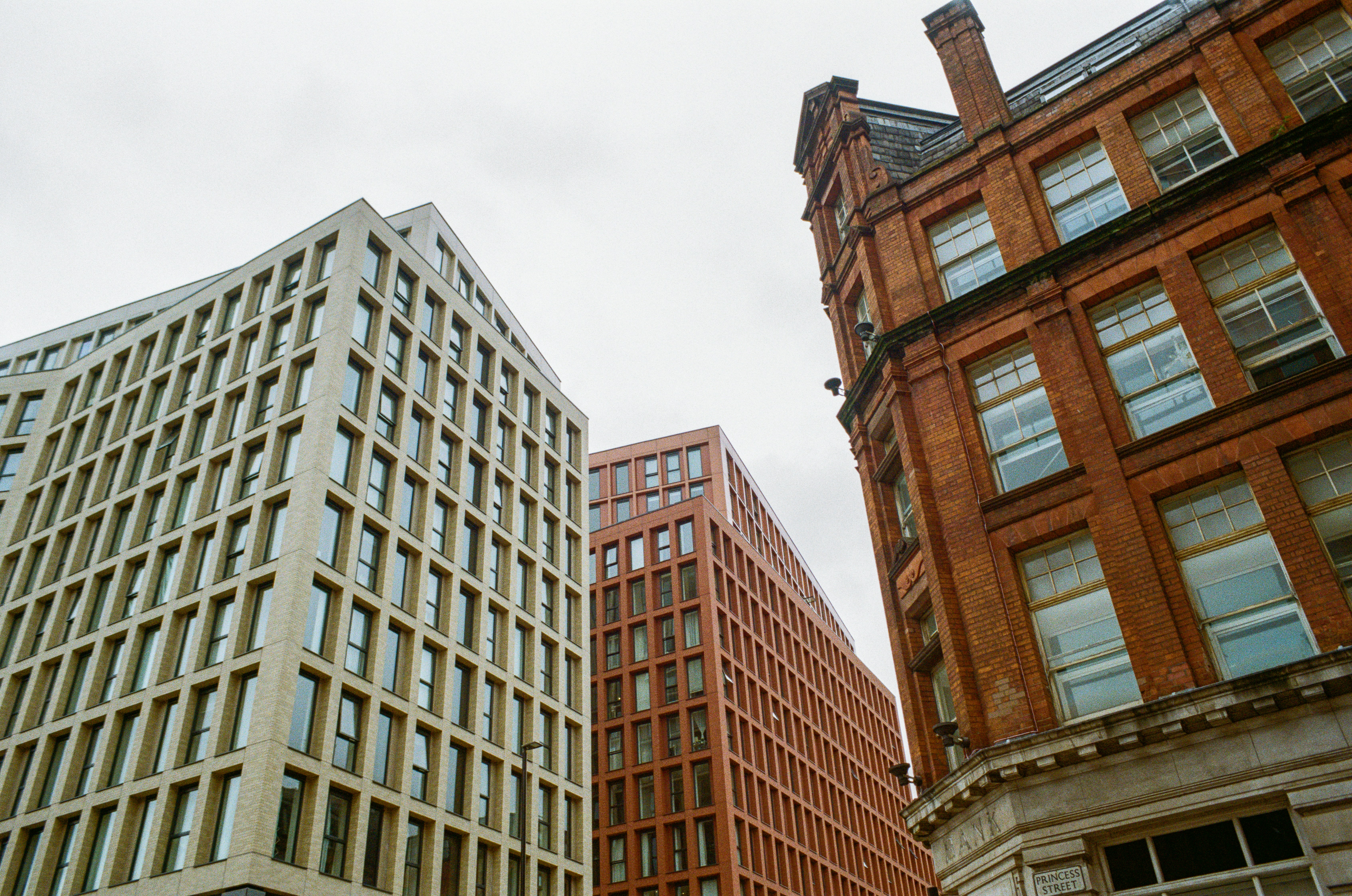 A couple of tall buildings sitting next to each other photo – Free ...