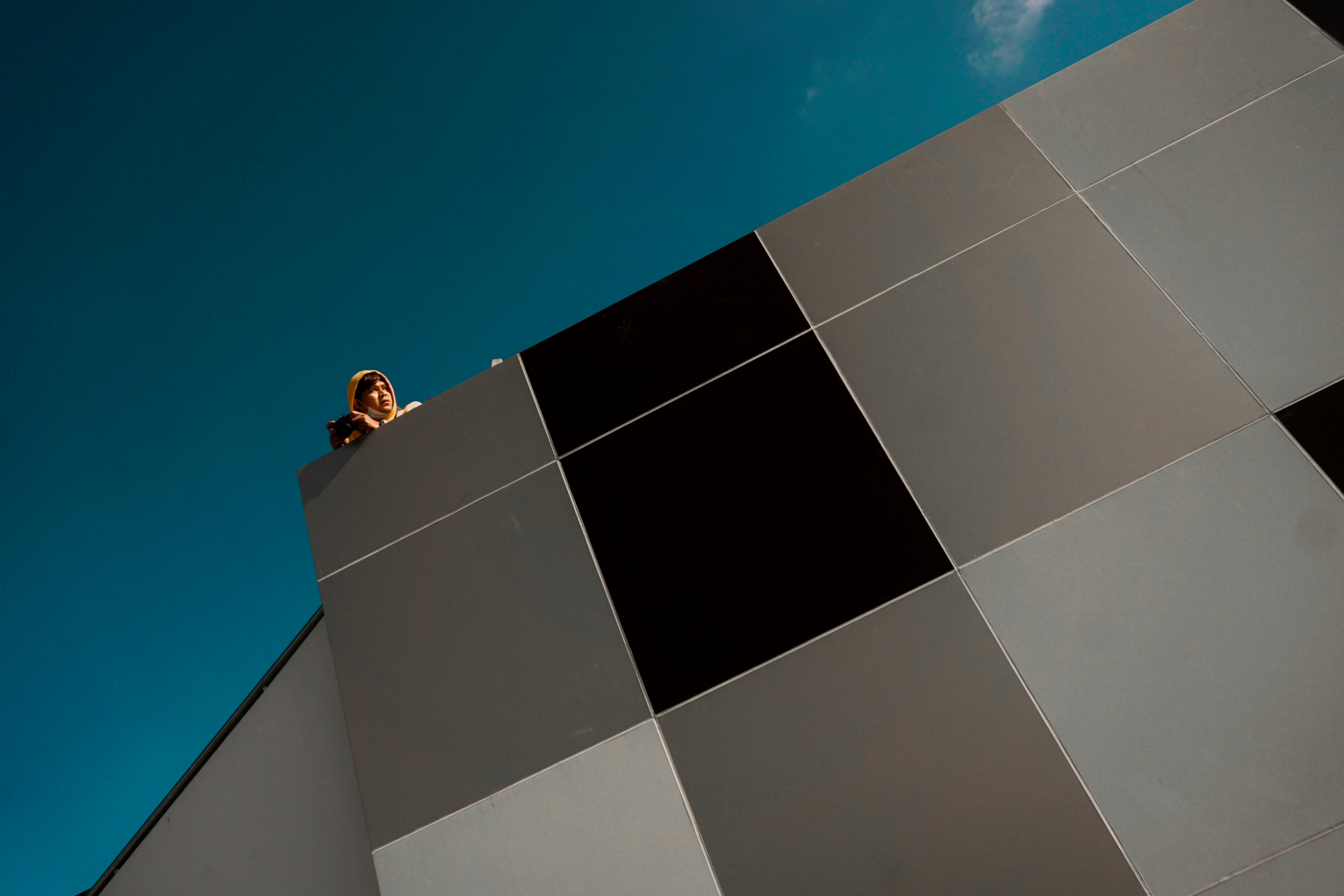 Contemplation on a Slanted Checkerboard Facade