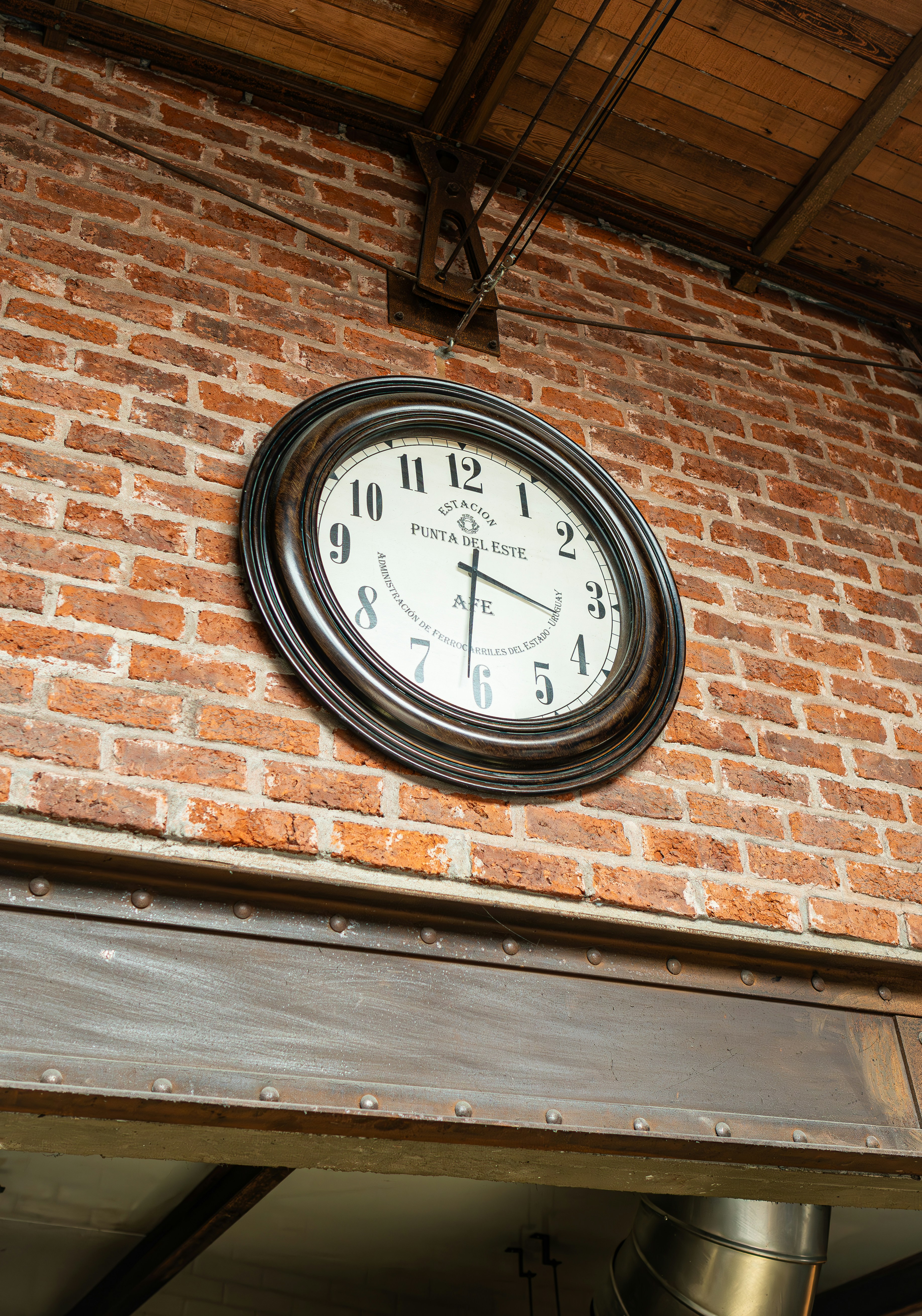 A clock mounted to the side of a brick building photo – Free Punta del ...