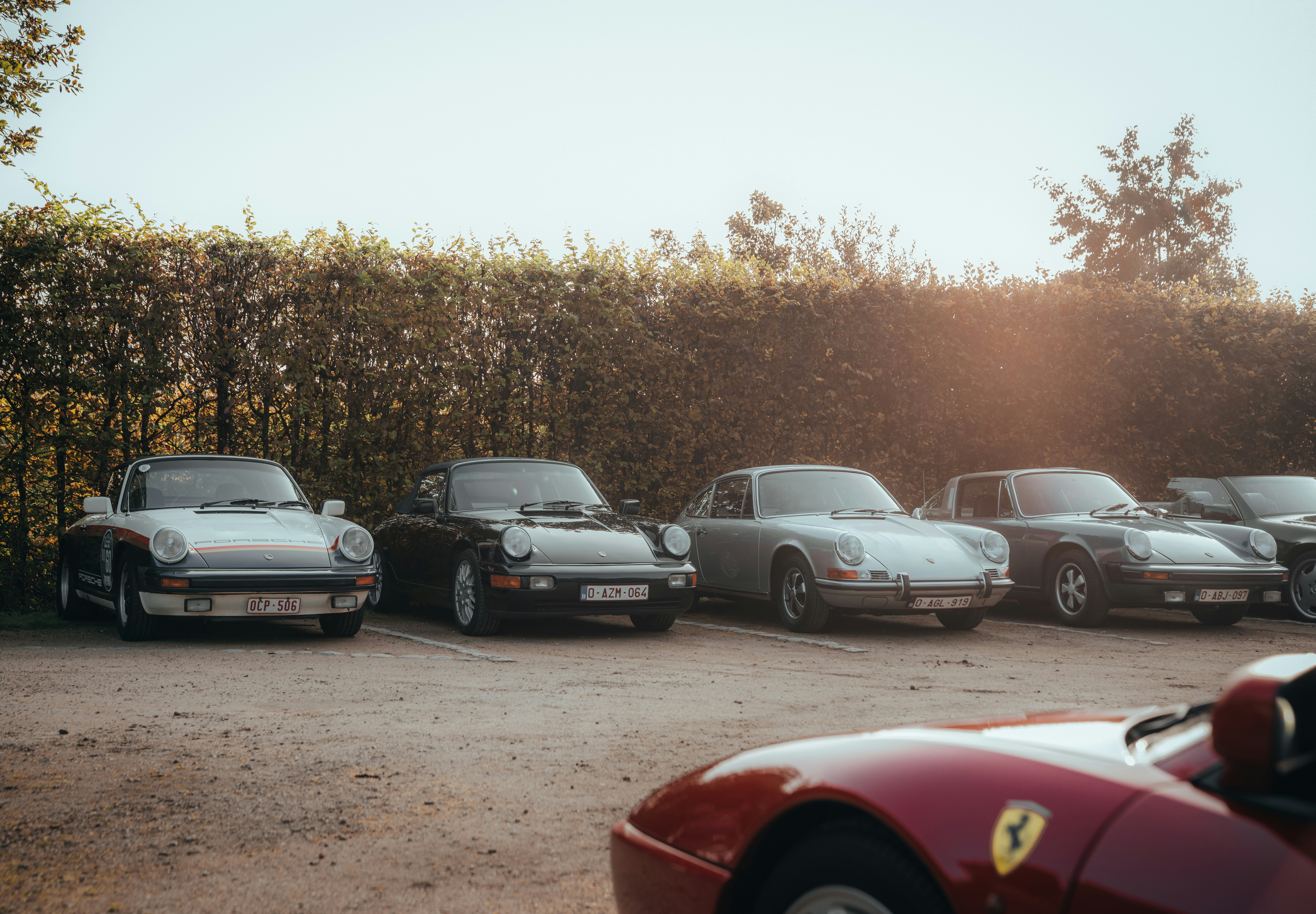 A group of cars parked next to each other in a parking lot photo – Free ...