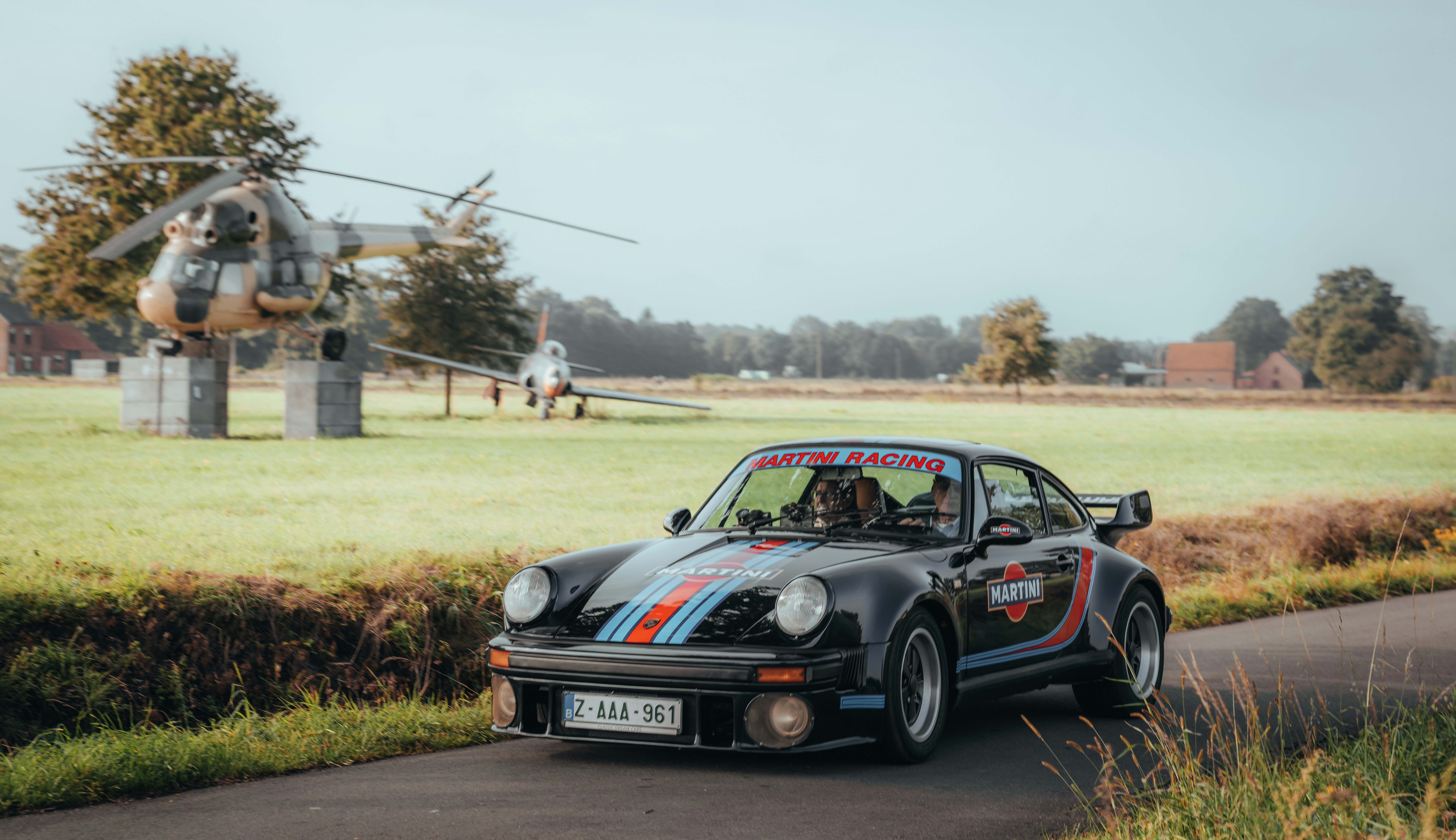 A car driving down a road next to a helicopter photo – Free Classic ...
