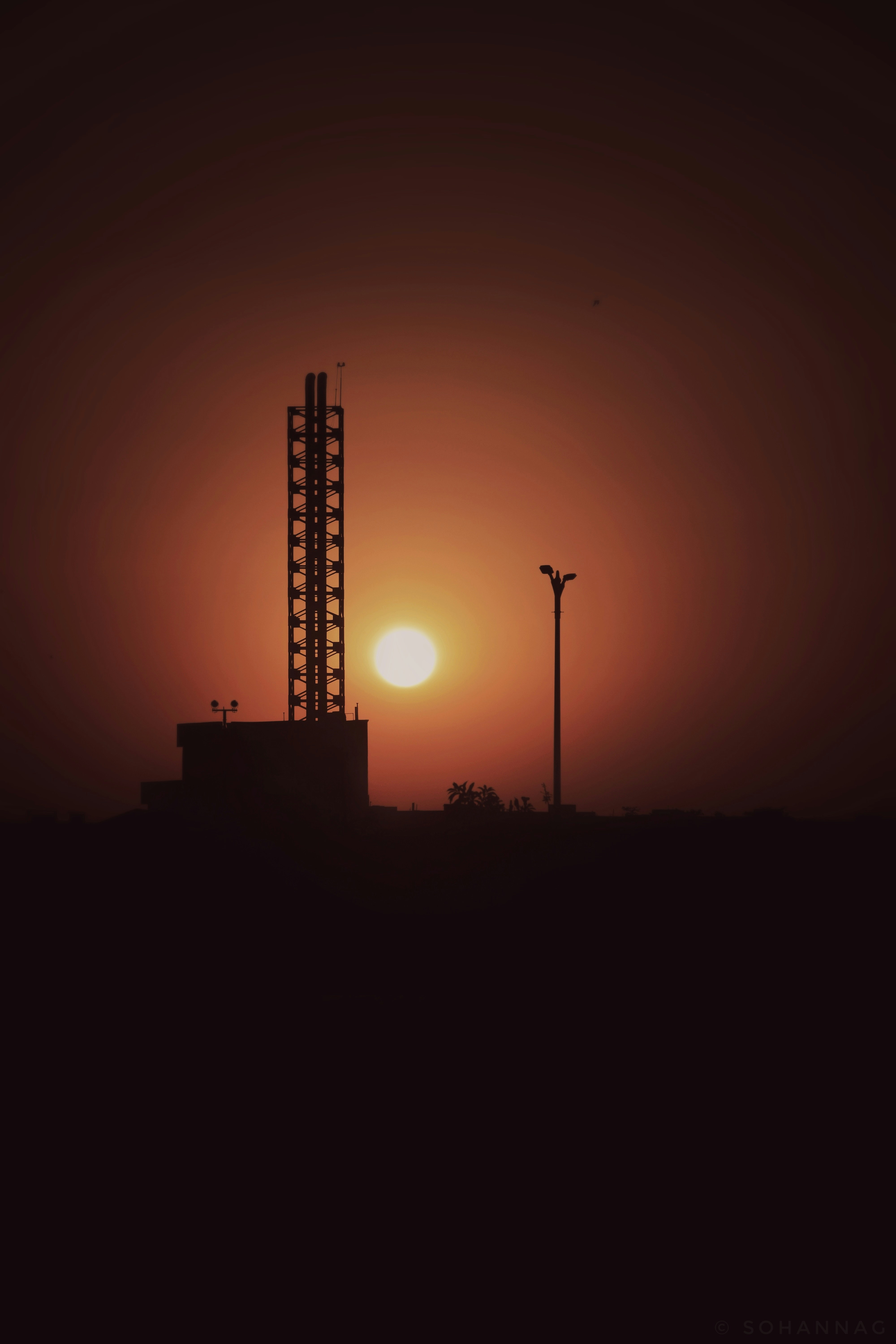 Dusk Halo over a Lone Launch Pad Silhouette