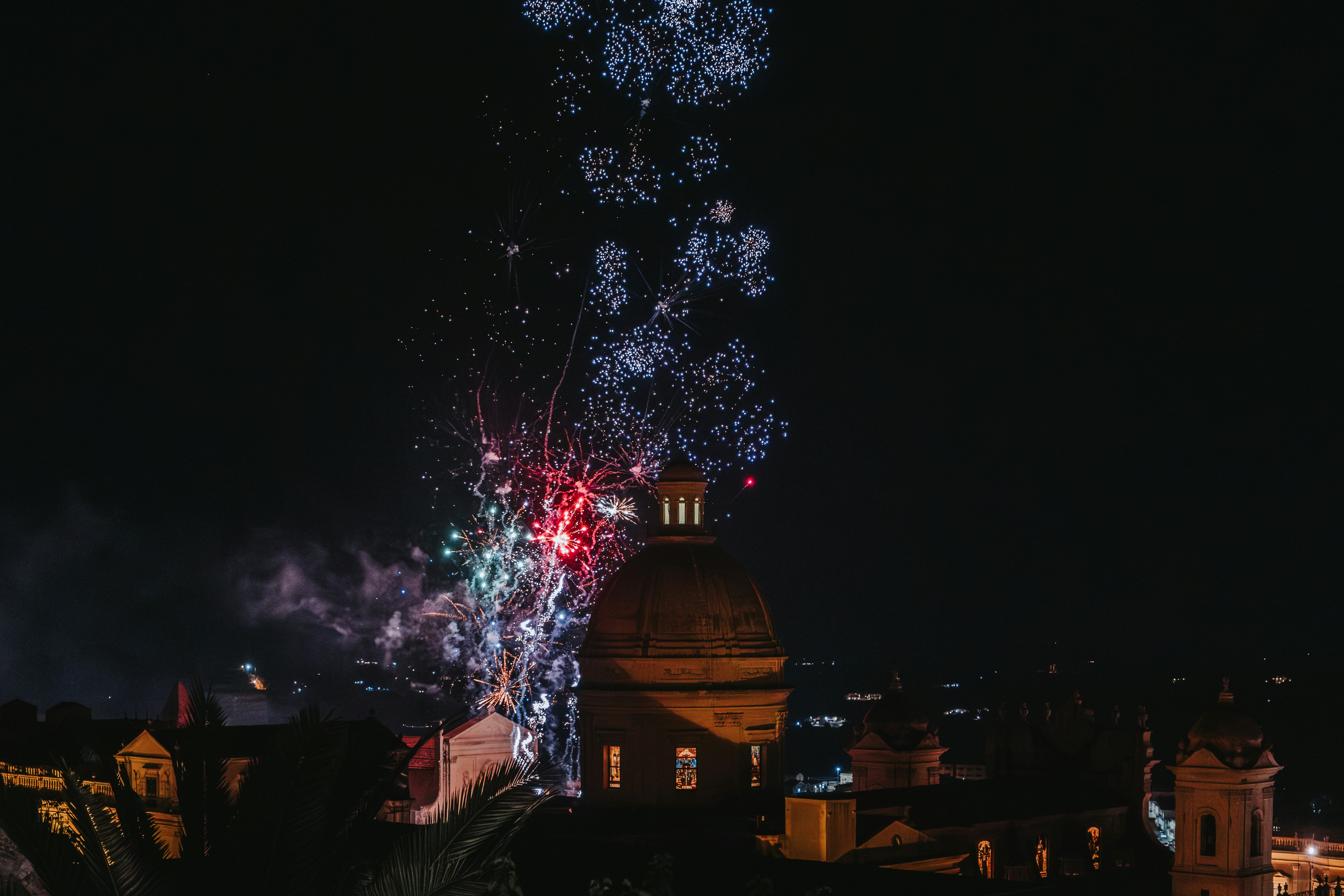 Nighttime Celebration Over Ancient Architecture