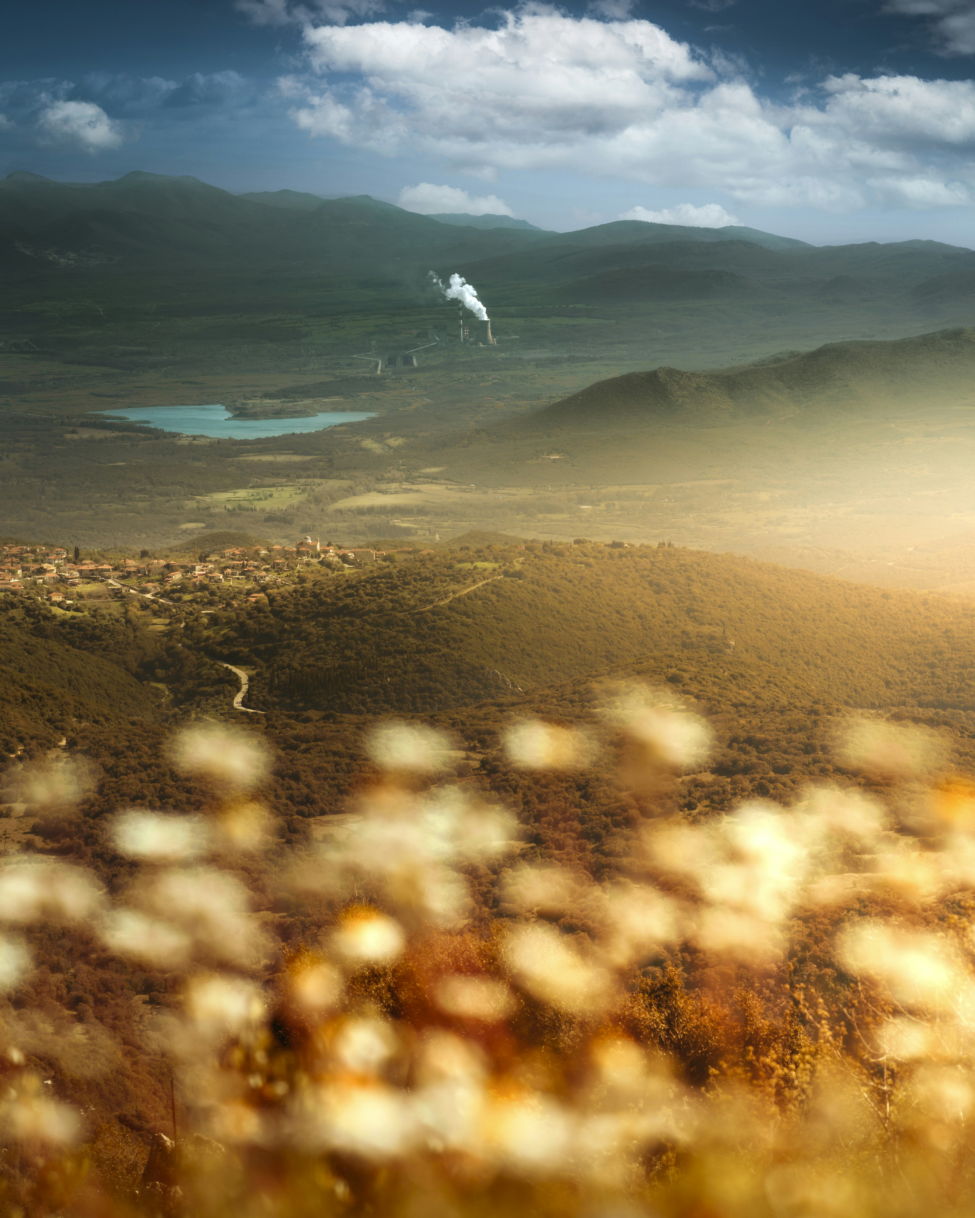 Distant Smokestack Looms Over a Golden Moor at Dusk