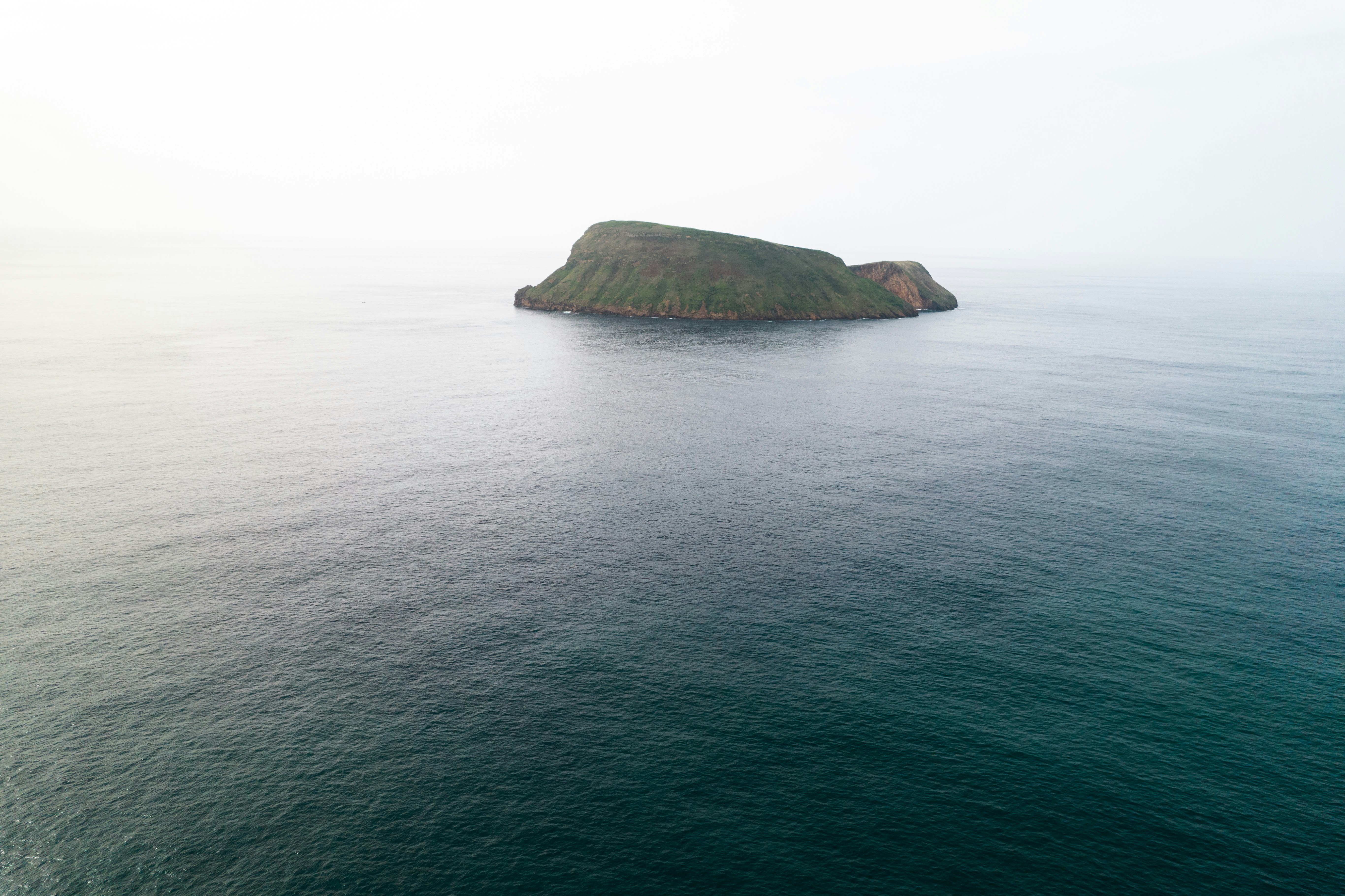 small island close to Terceira in Azores | a small island in the middle of the ocean