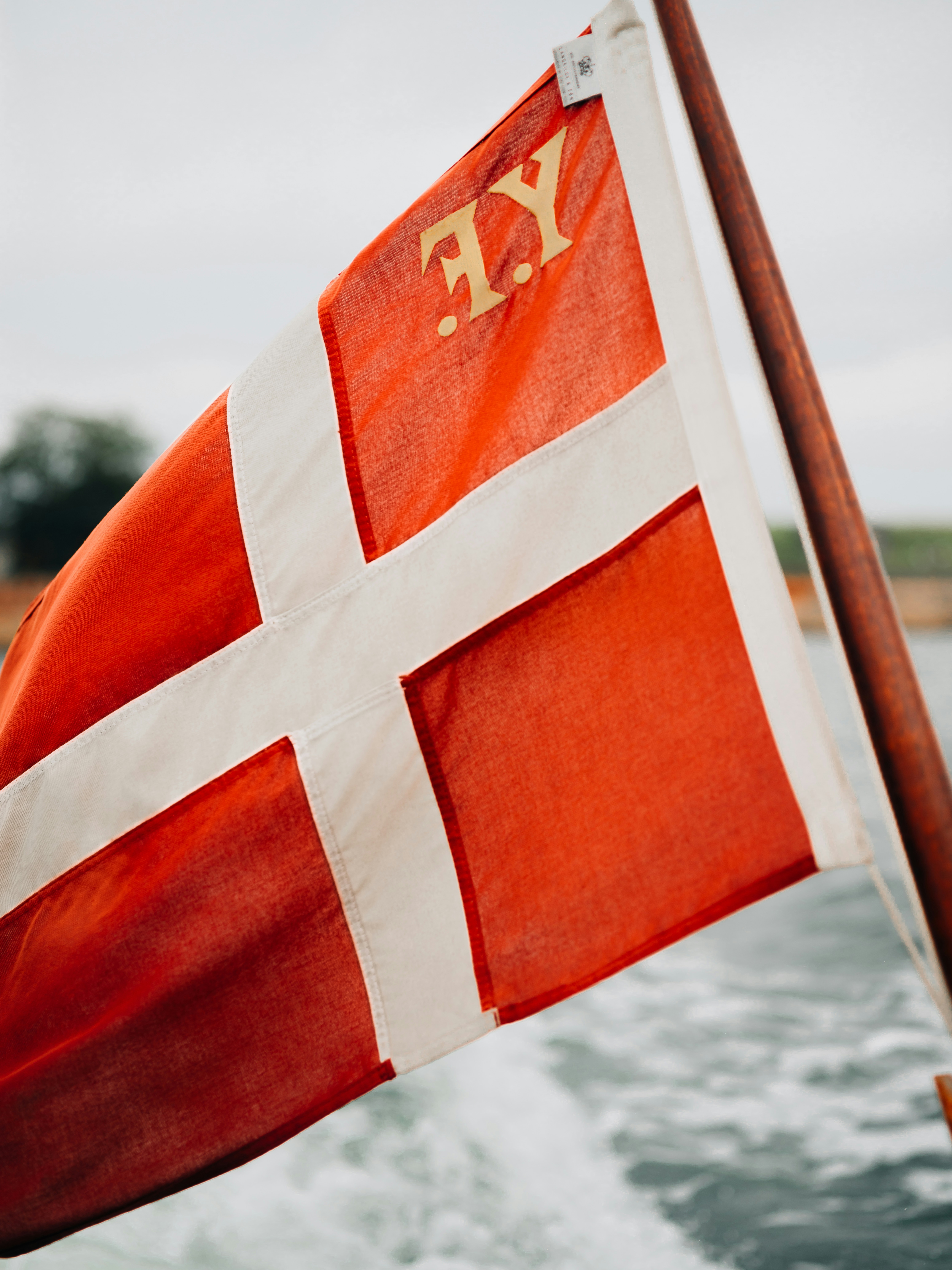 Bow Flag at Sea: Danish Banner Riding the Wake